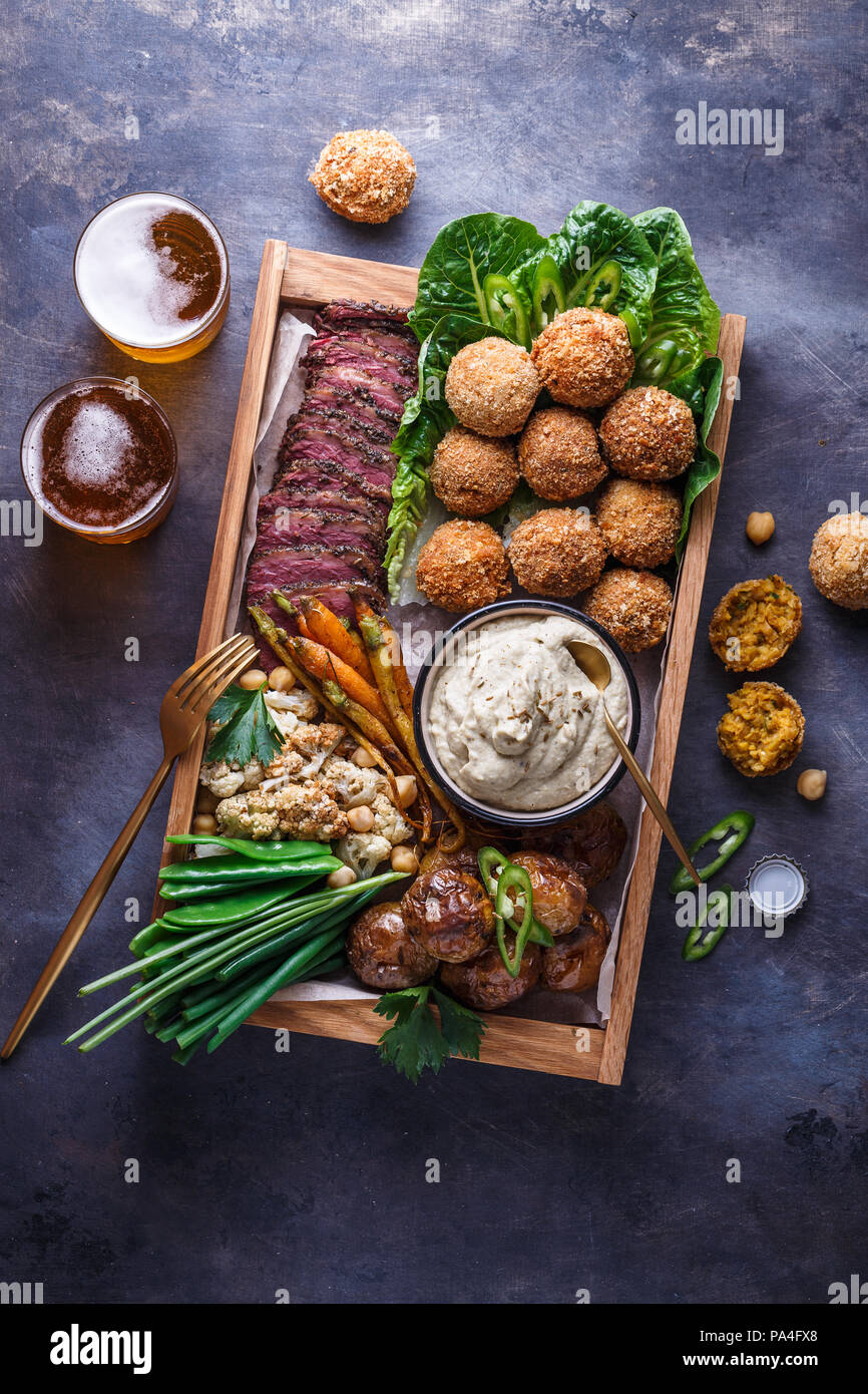Middle eastern party food: falafel, babaghanoush, potatoes beef green ...