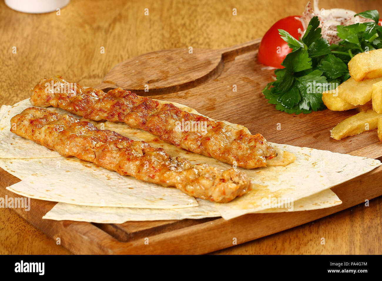 Chicken Adana kebap served with lavash Stock Photo - Alamy