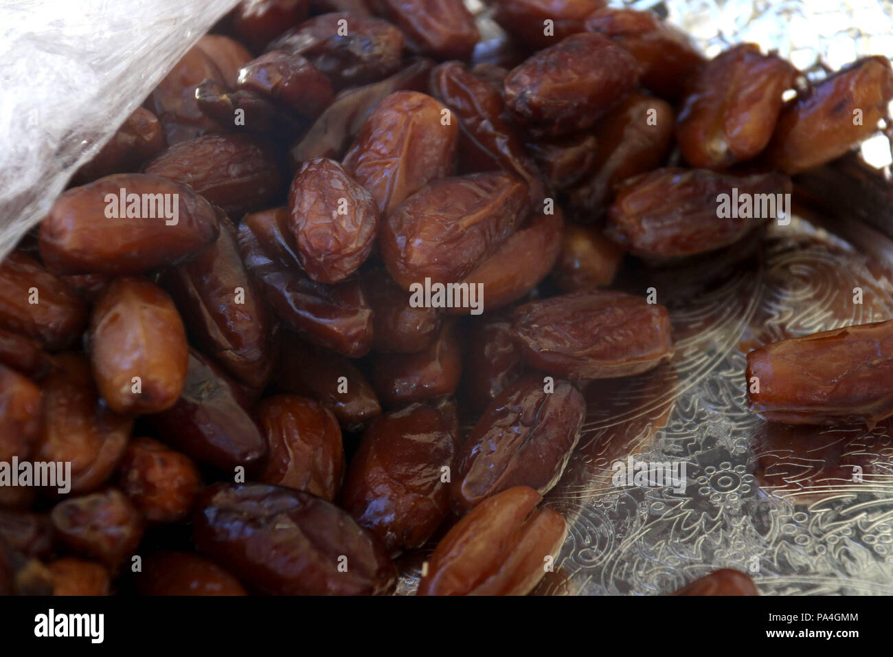 Fresh dates on a silver platter Stock Photo - Alamy