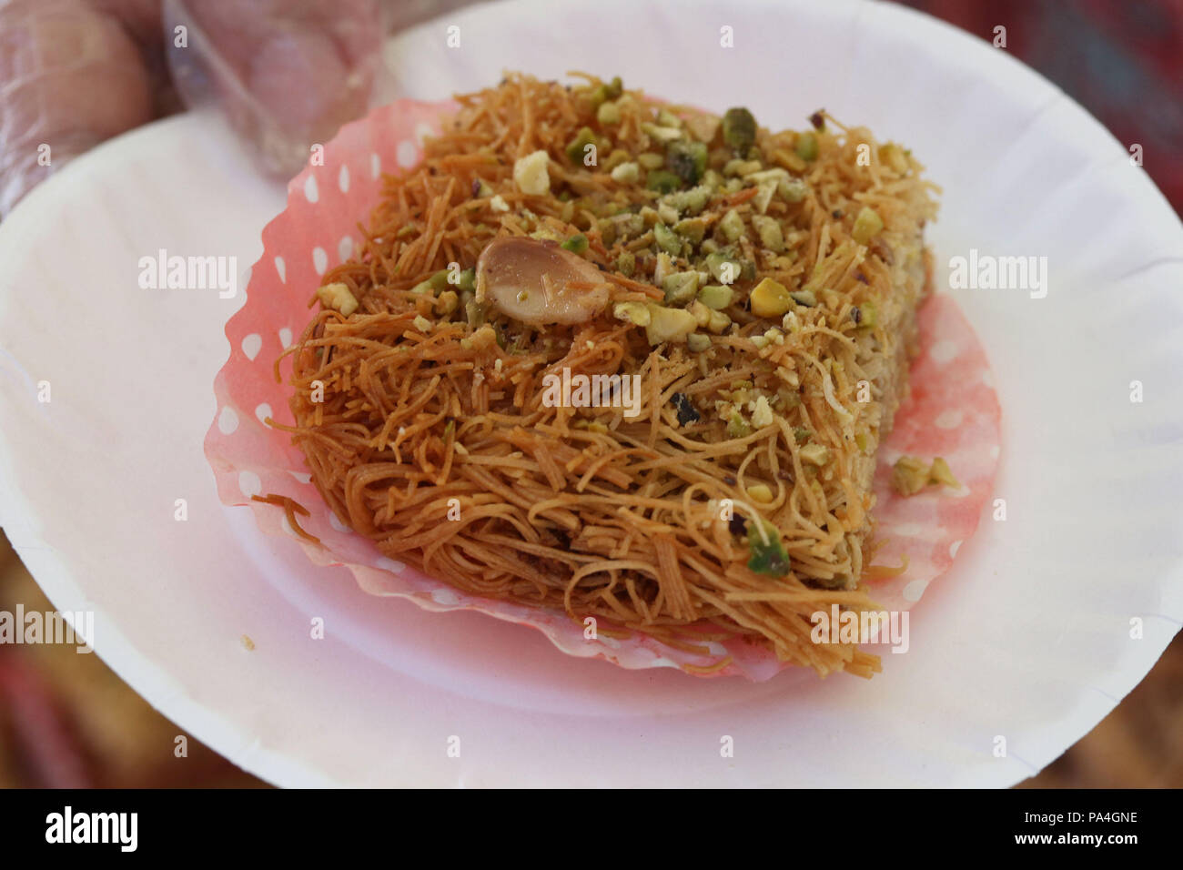 Kanafeh, a Palestinian dessert made with noodle-like pastry and layered ...