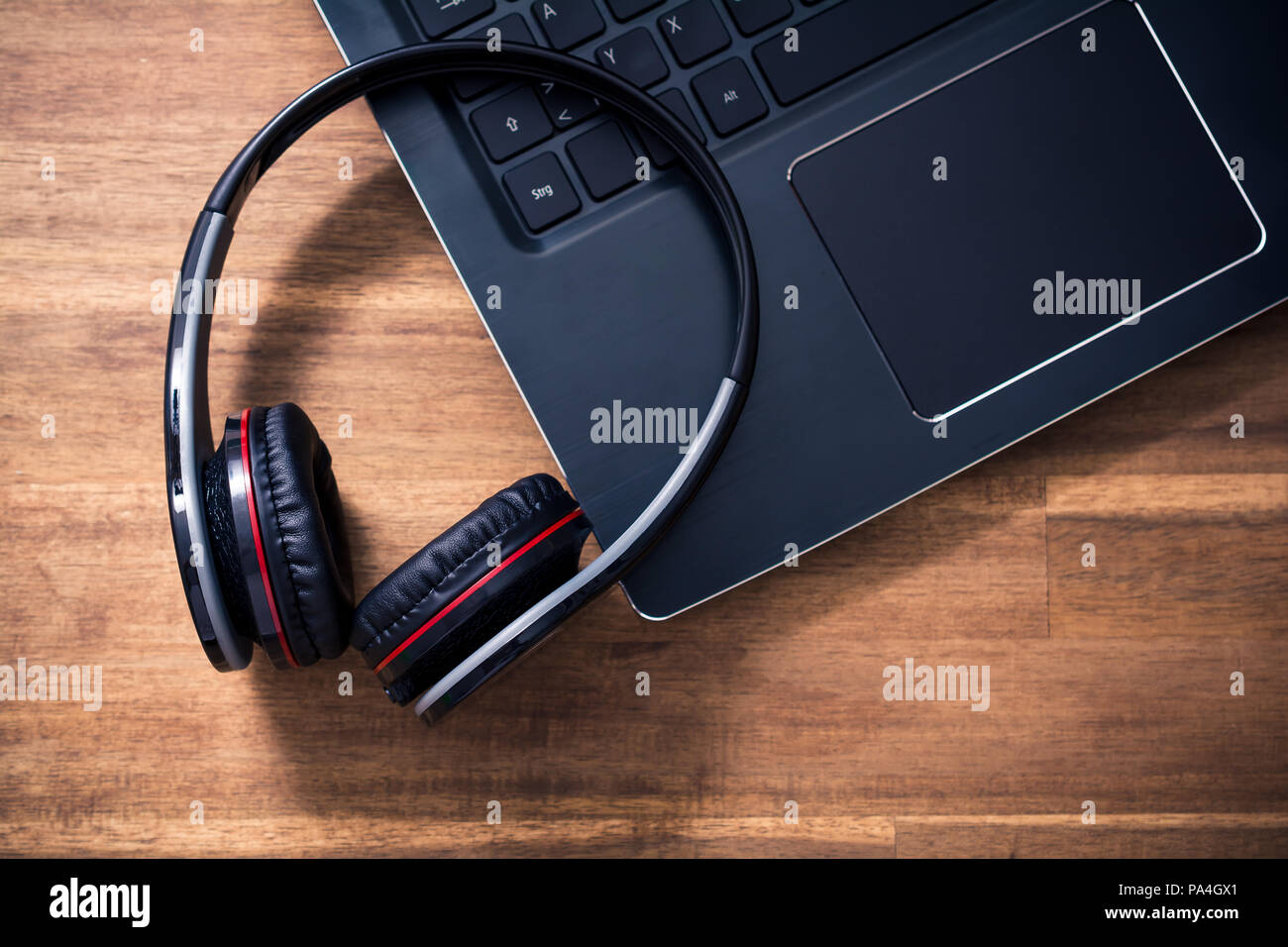 Black Wireless Overhead Headset Lying On The Corner Of A Notebook ...
