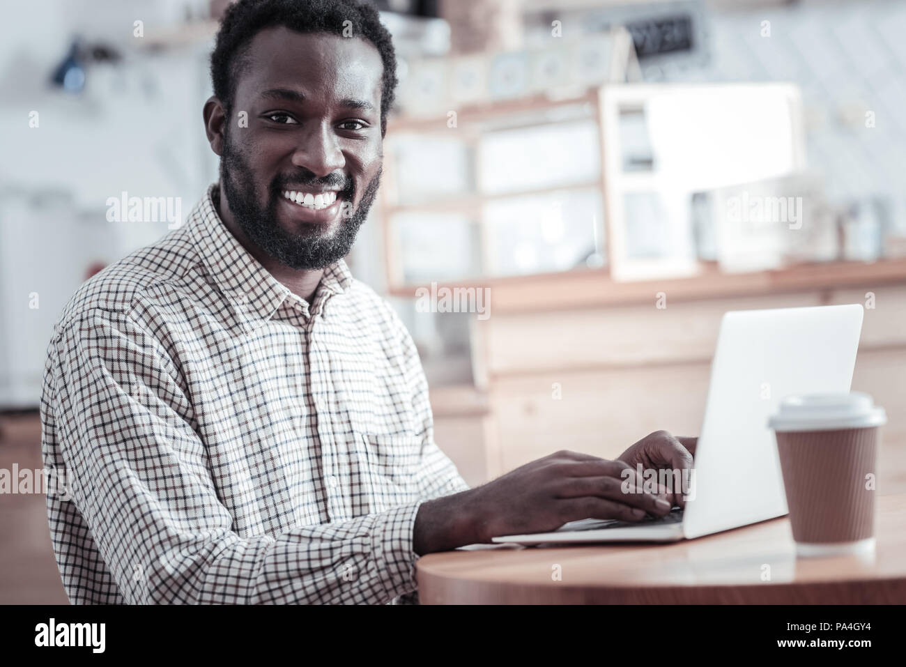 Delighted happy man typing Stock Photo - Alamy