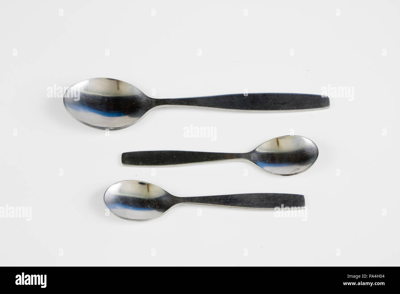 Cutlery arranged on a white kitchen table. Accessories for kitchen and ...