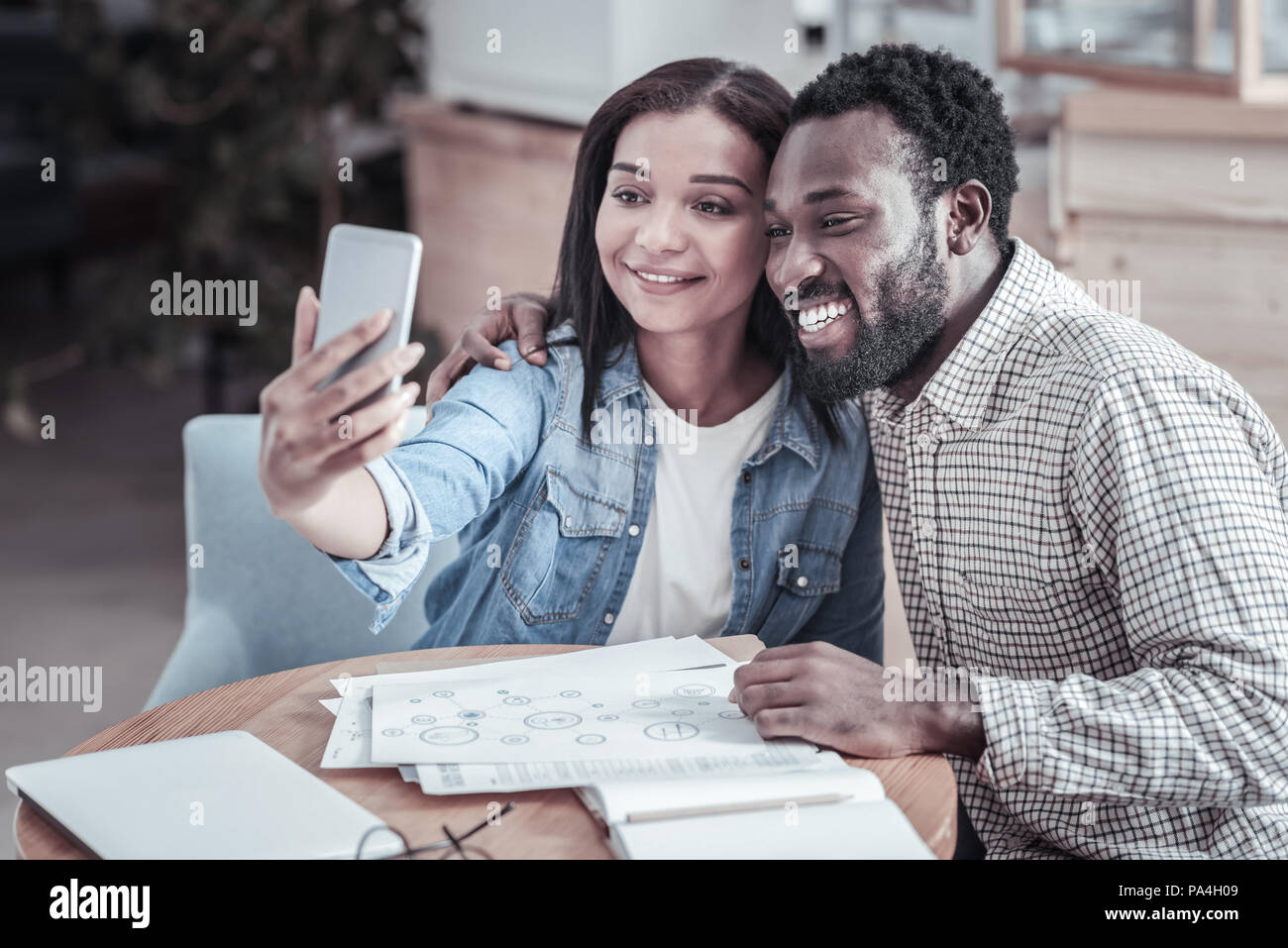 Delighted young people looking into the camera Stock Photo - Alamy