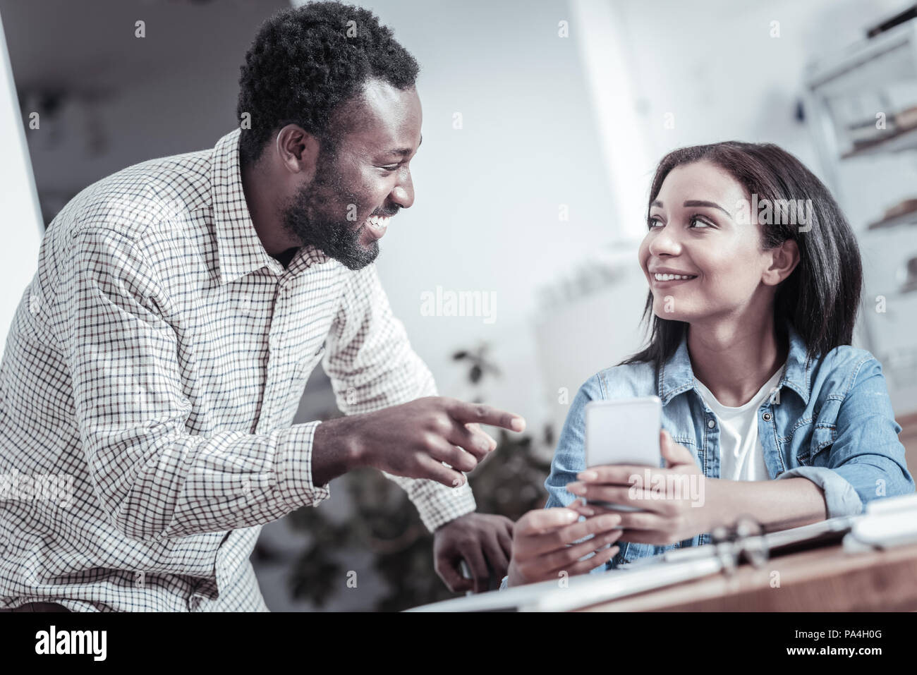 Delighted positive man pointing at the screen Stock Photo - Alamy