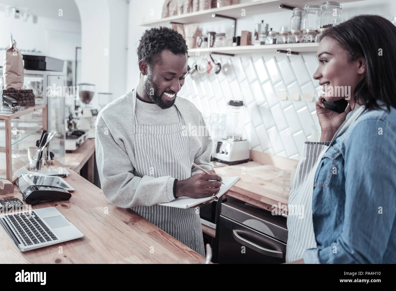 Joyful smart man taking notes Stock Photo - Alamy
