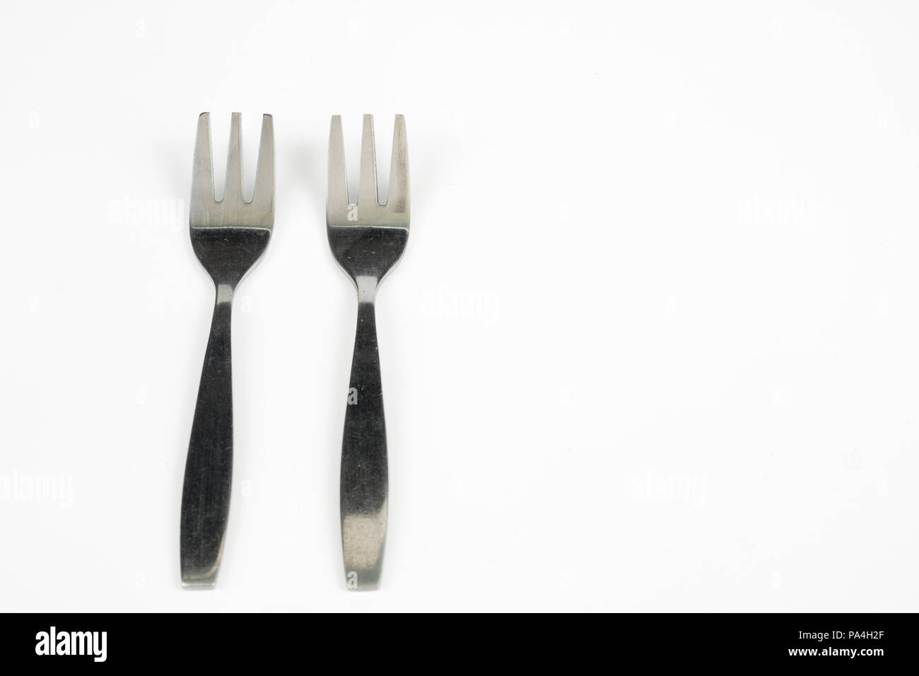 Cutlery arranged on a white kitchen table. Accessories for kitchen and ...