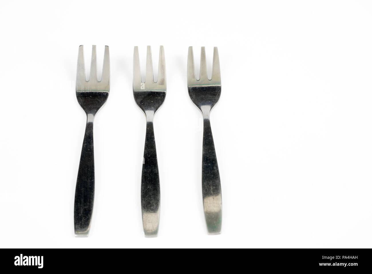 Cutlery arranged on a white kitchen table. Accessories for kitchen and ...