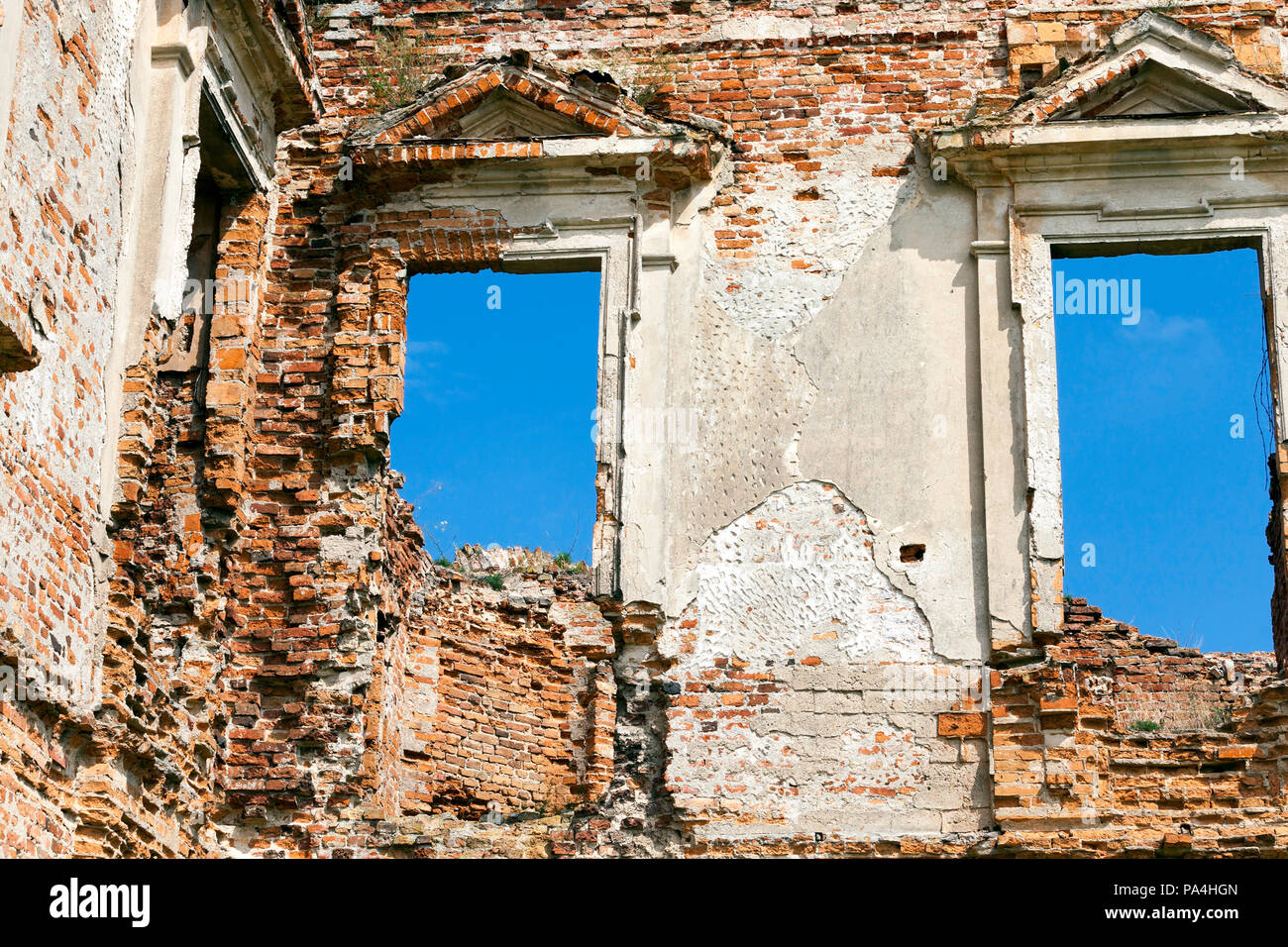 part of the wall of a ruined building with windows, a photo of a close ...