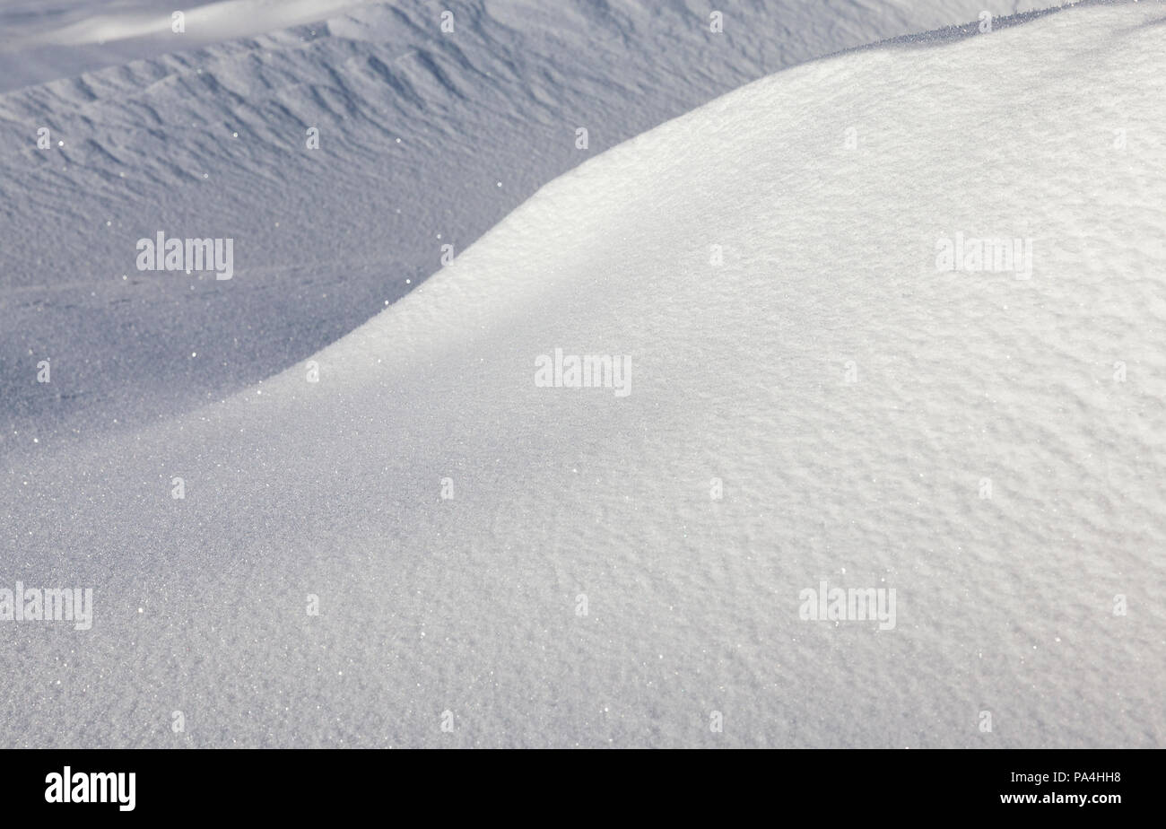 wavy and hilly surface of Deep snow drifts in the winter season ...