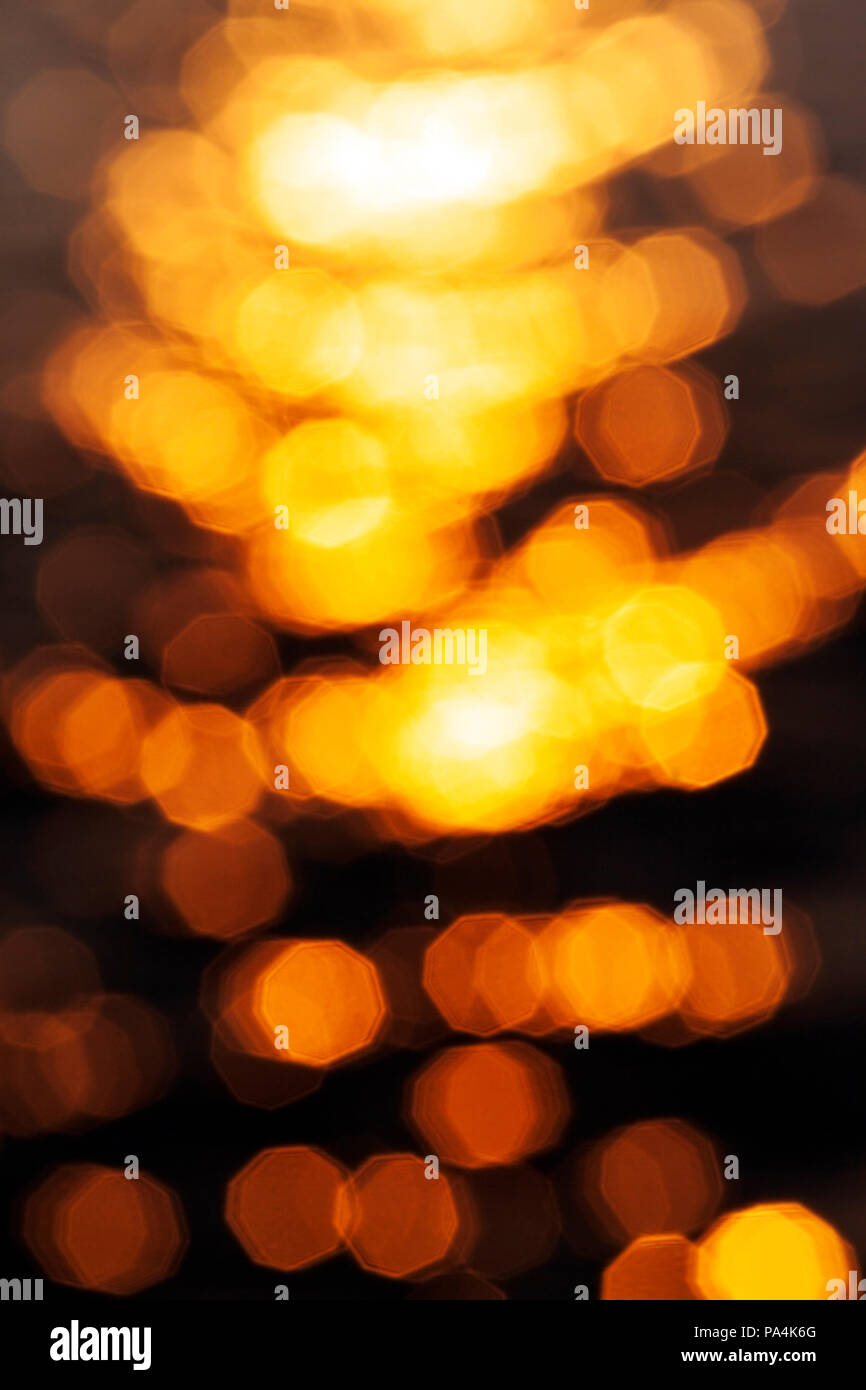 orange glare from water and sunlight at sunset, out of focus Stock ...