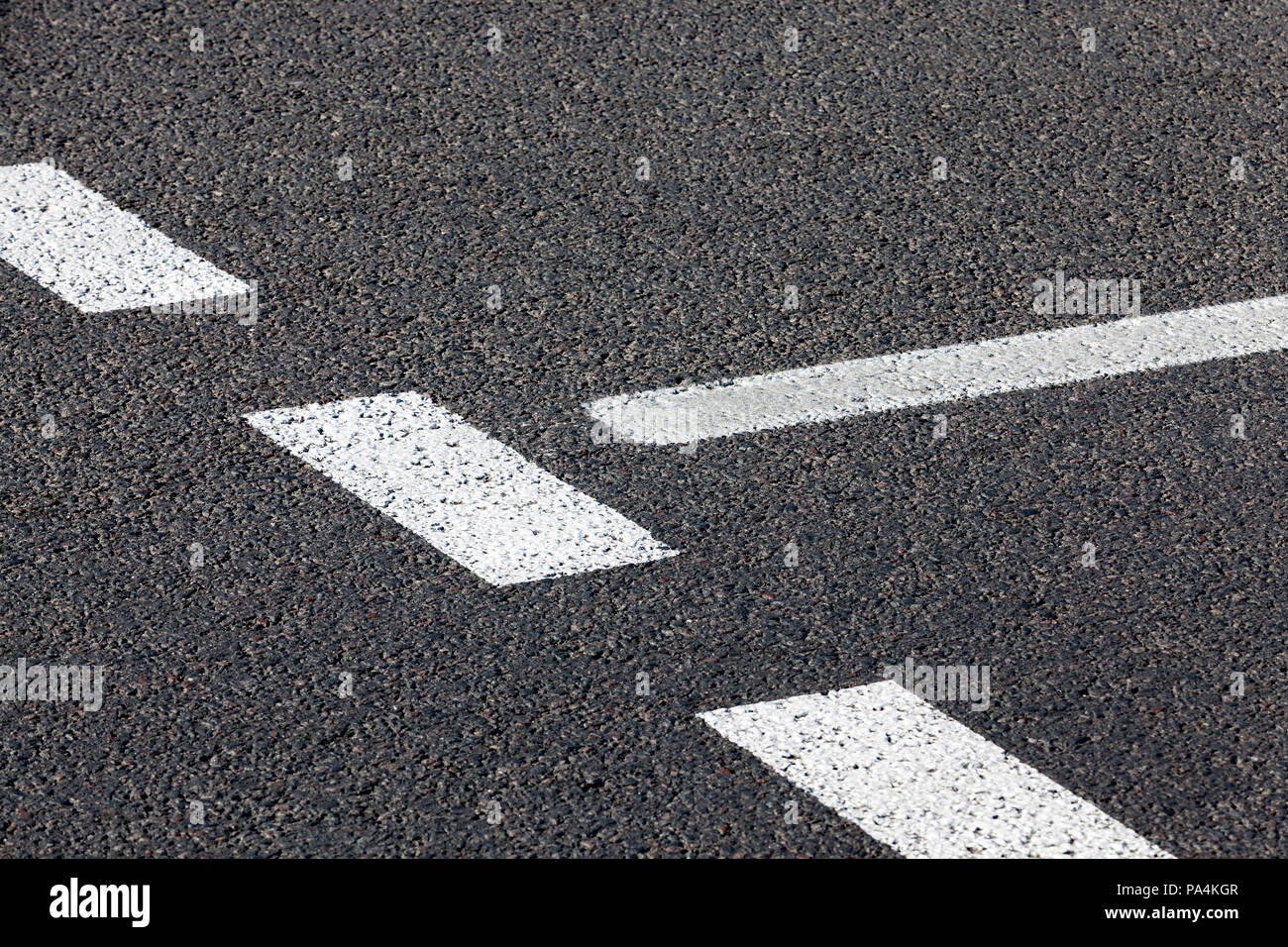 white road marking painted on asphalt road, closeup Stock Photo - Alamy