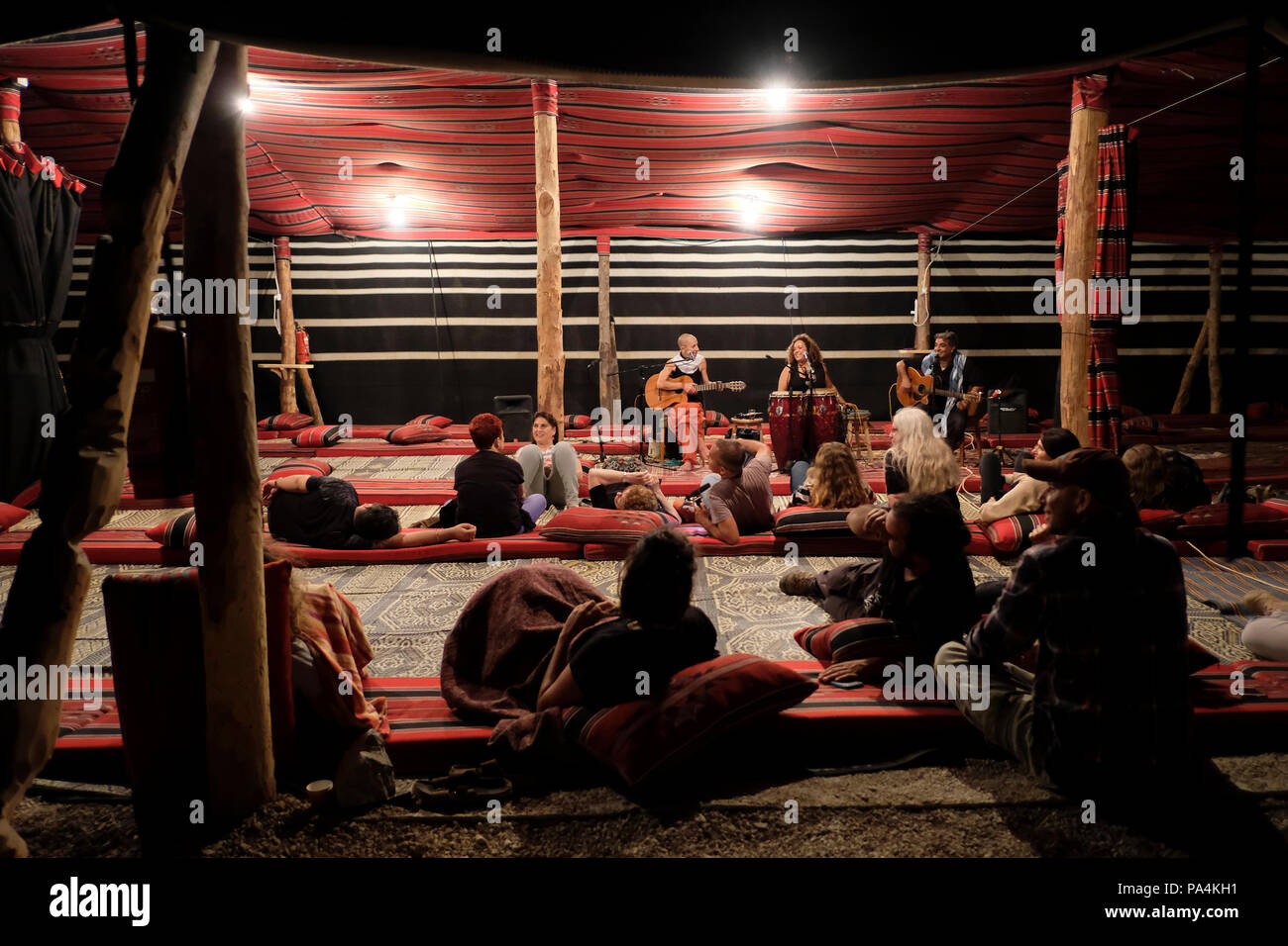 Hikers enjoying musical entertainment under a Bedouin tent in Be’erot ...