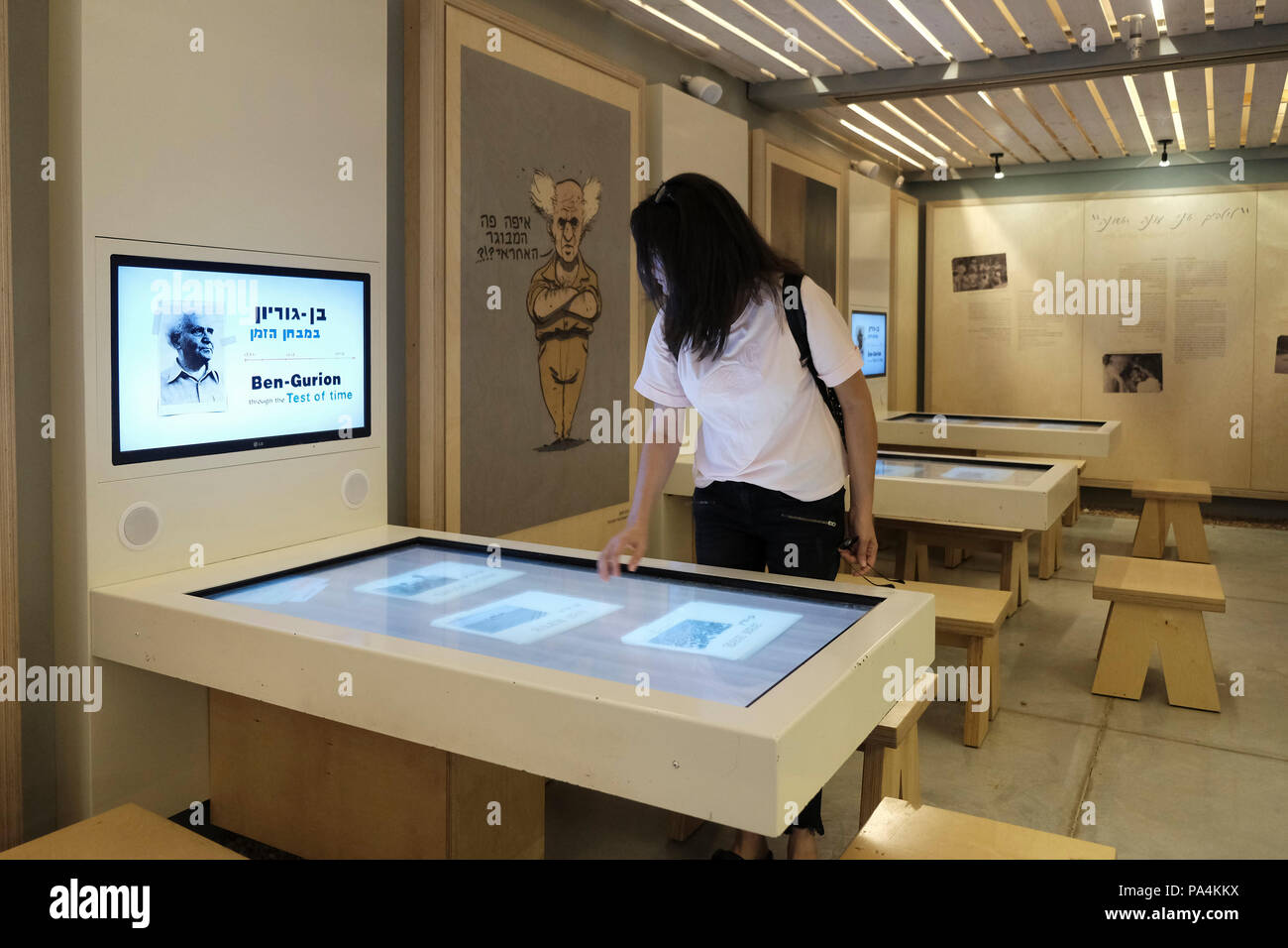 Israeli woman using an interactive education interface inside the visitor center of David Ben ...
