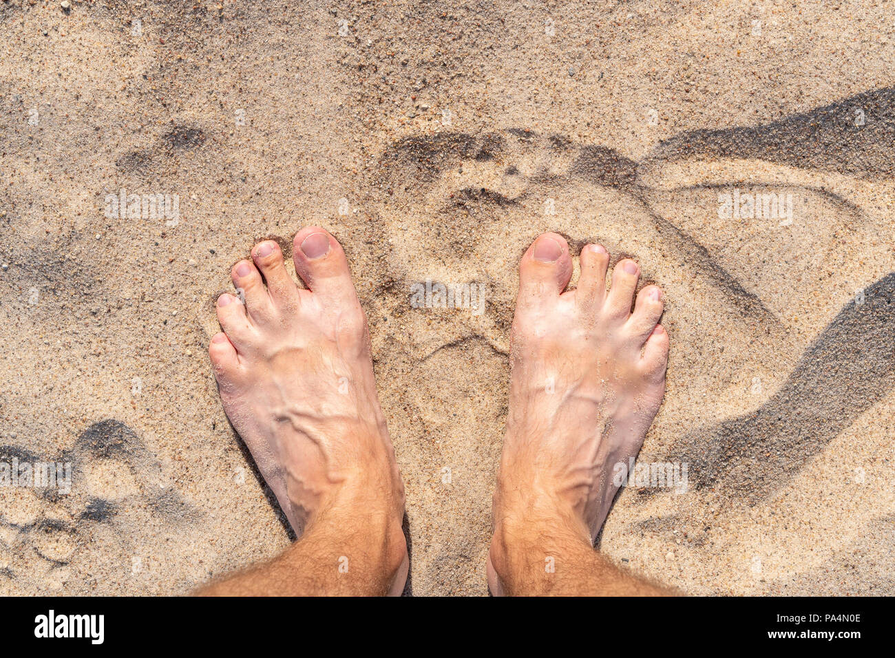 Self photo of feet on beach sand background, top view Stock Photo - Alamy