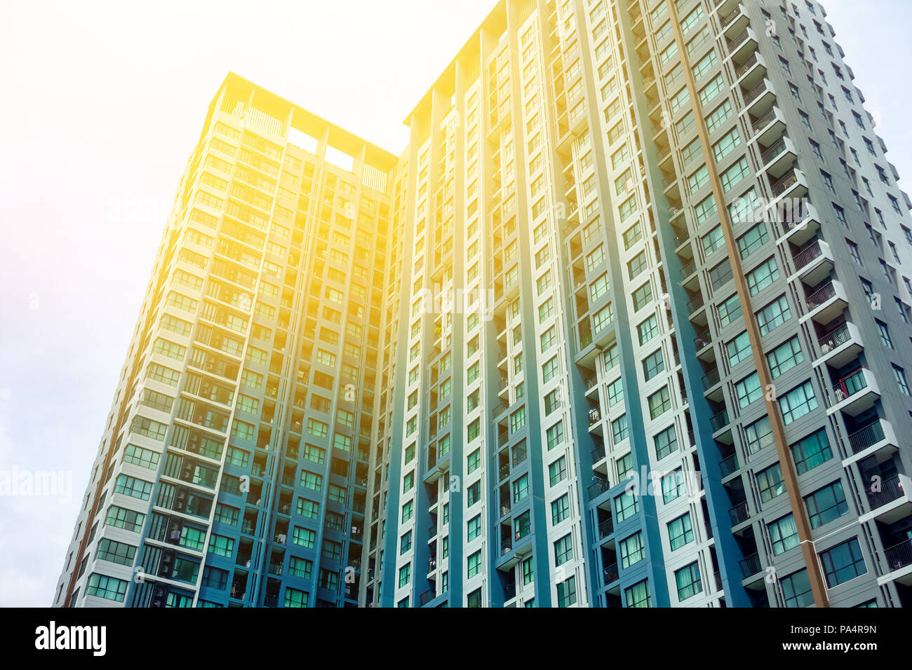 Blurred image of building with blue sky and sun flare background Stock ...