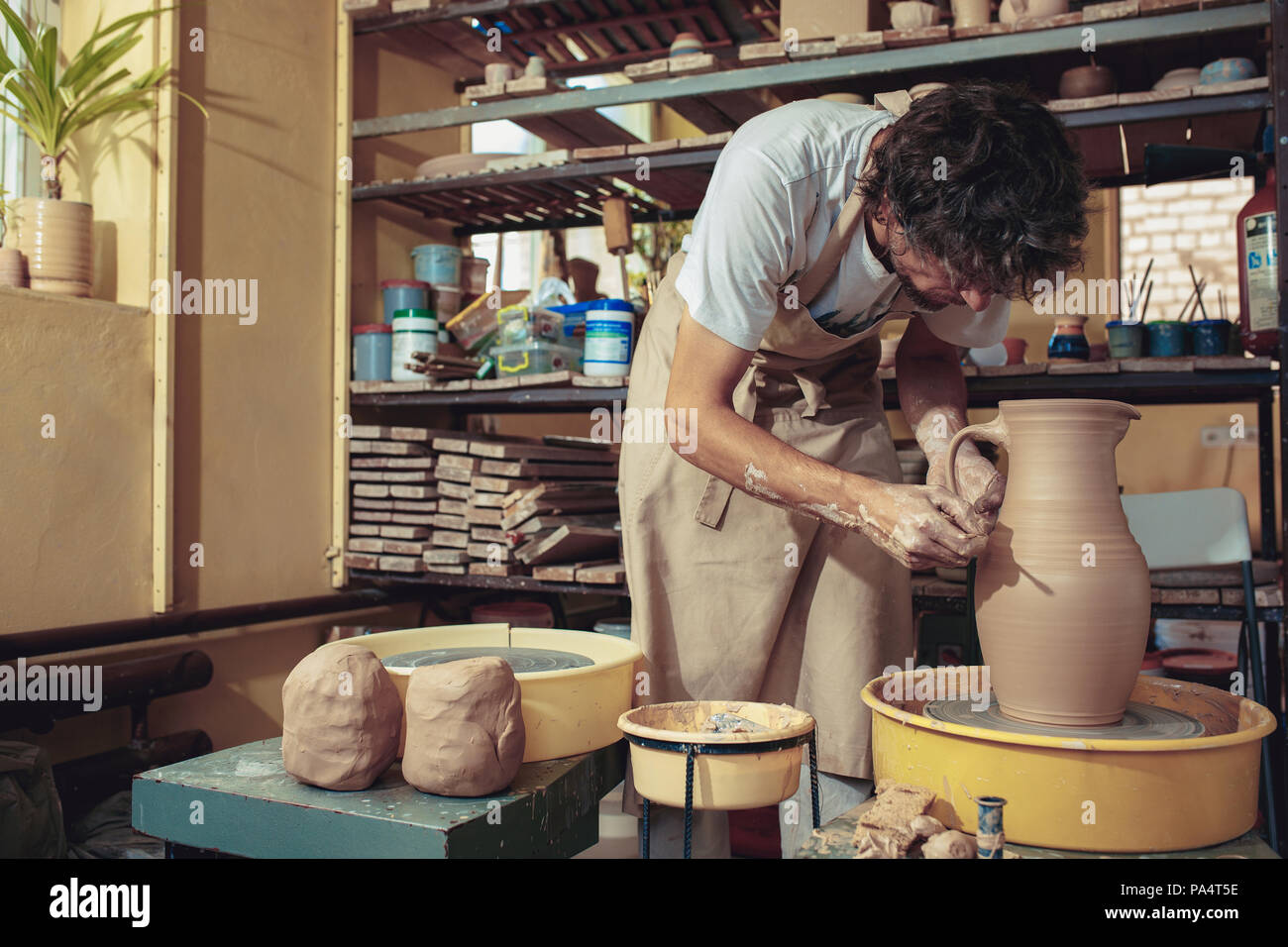 Creating a jar or vase of white clay close-up. Master crock Stock Photo ...