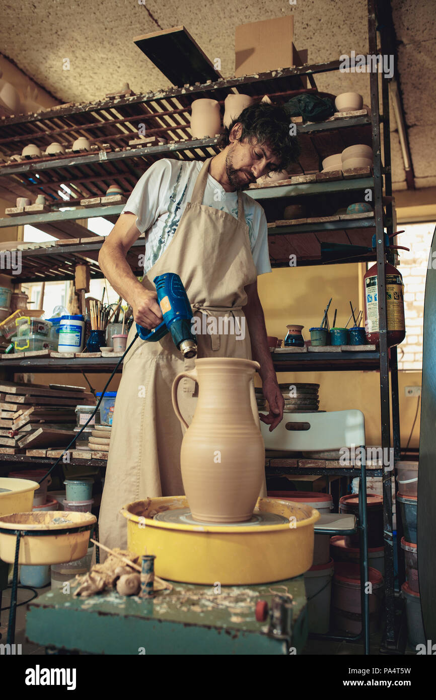 Creating a jar or vase of white clay close-up. Master crock Stock Photo ...