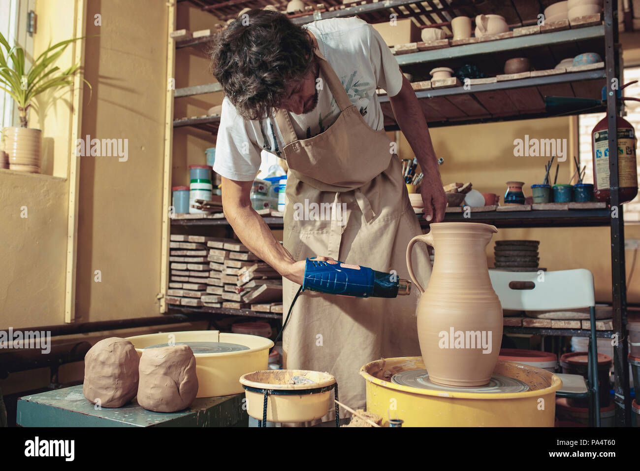 Creating a jar or vase of white clay close-up. Master crock Stock Photo ...