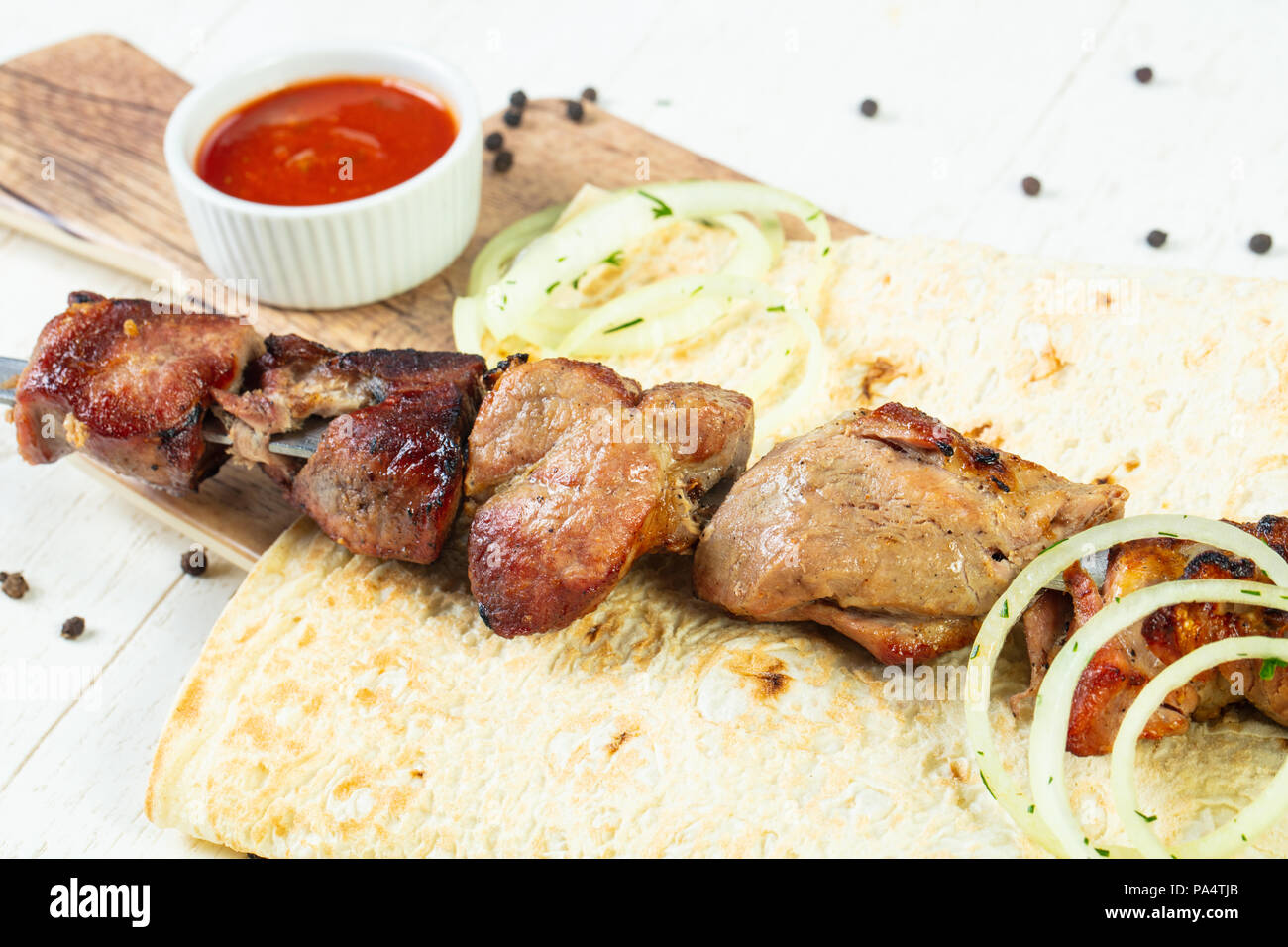 Grilled pork kebab with onion and sauce Stock Photo - Alamy