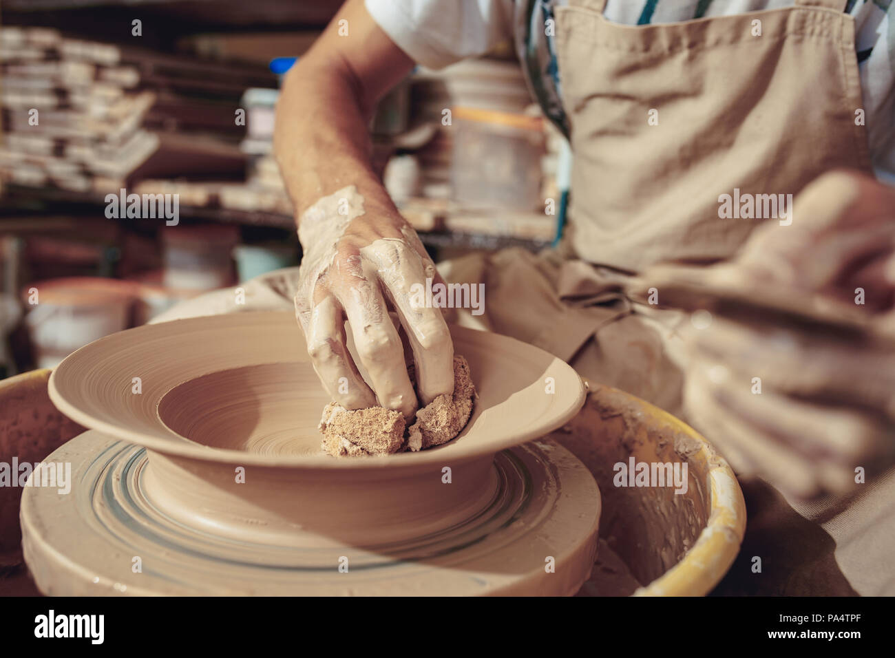 Creating a jar or vase of white clay close-up. Master crock. Man hands ...