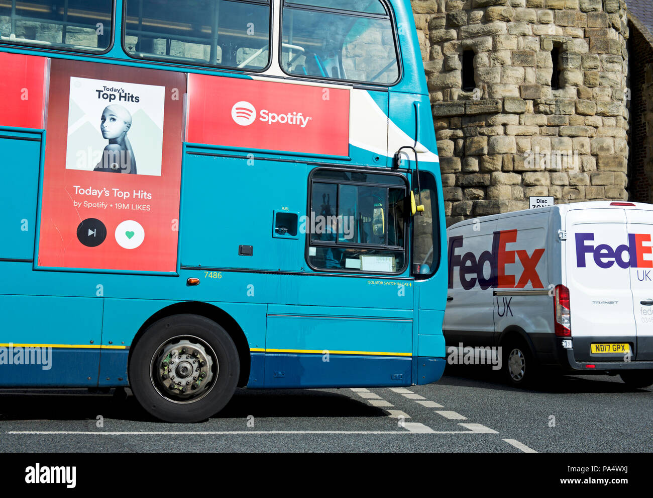 Bus and FedEx courier van, at Bondgate Tower, Alnwick, Northumberland ...