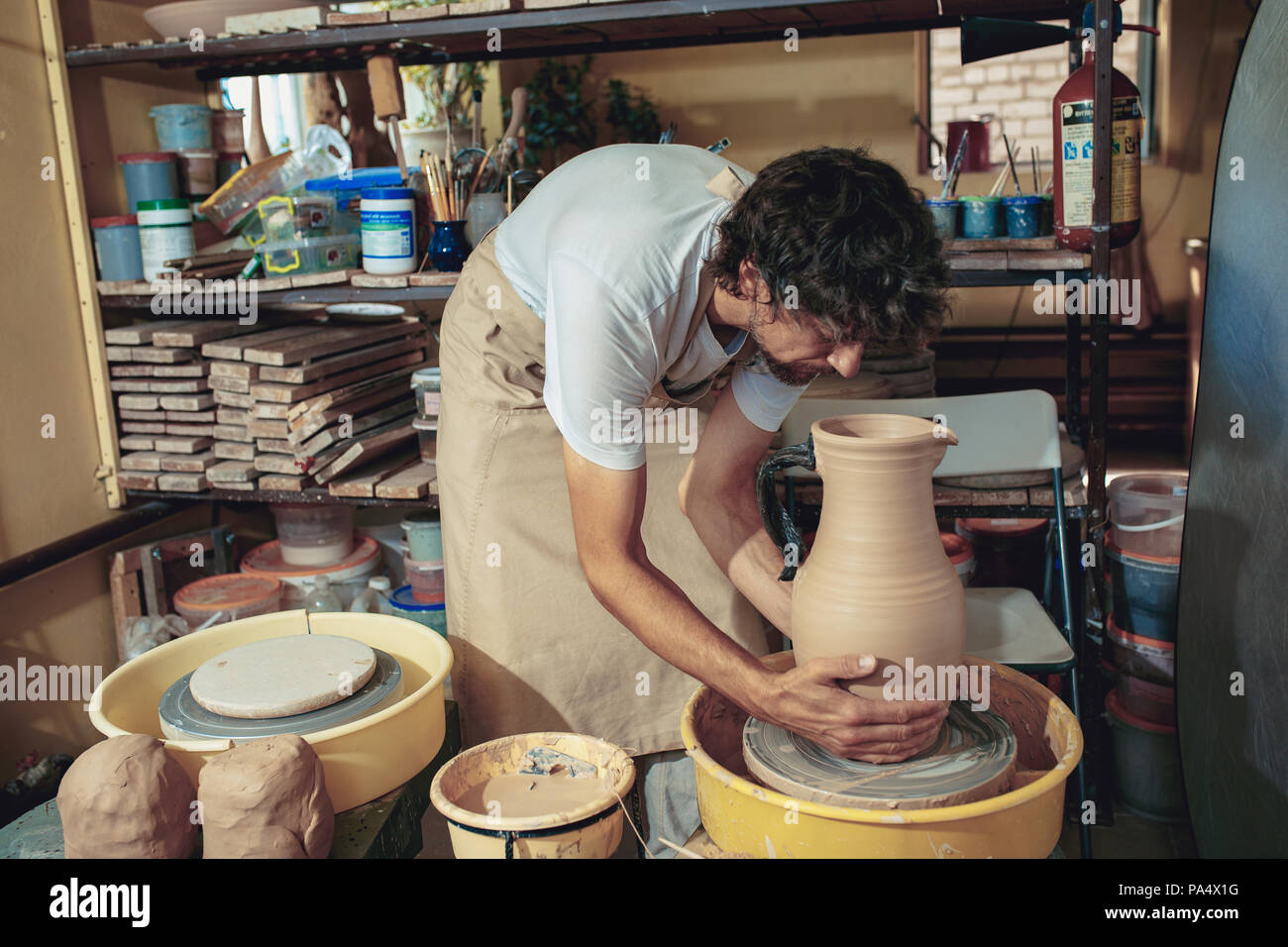 Creating a jar or vase of white clay close-up. Master crock Stock Photo ...