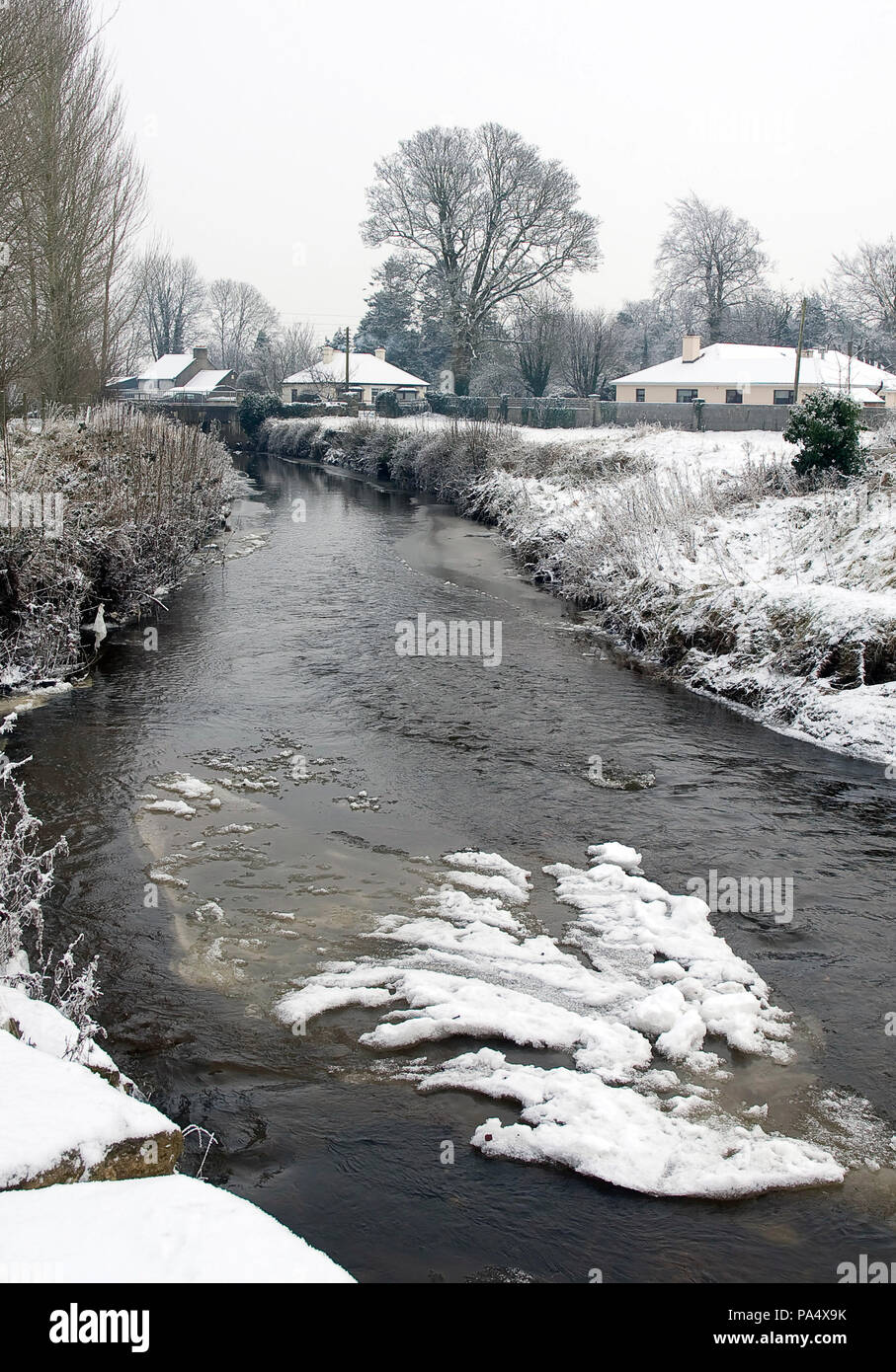 Light snow scenes with tree's and river with frost and ice Stock Photo ...