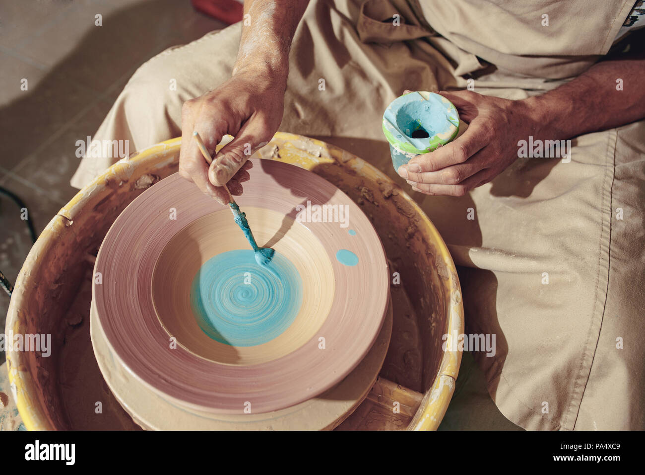 Creating a jar or vase of white clay close-up. Master crock. Man hands ...