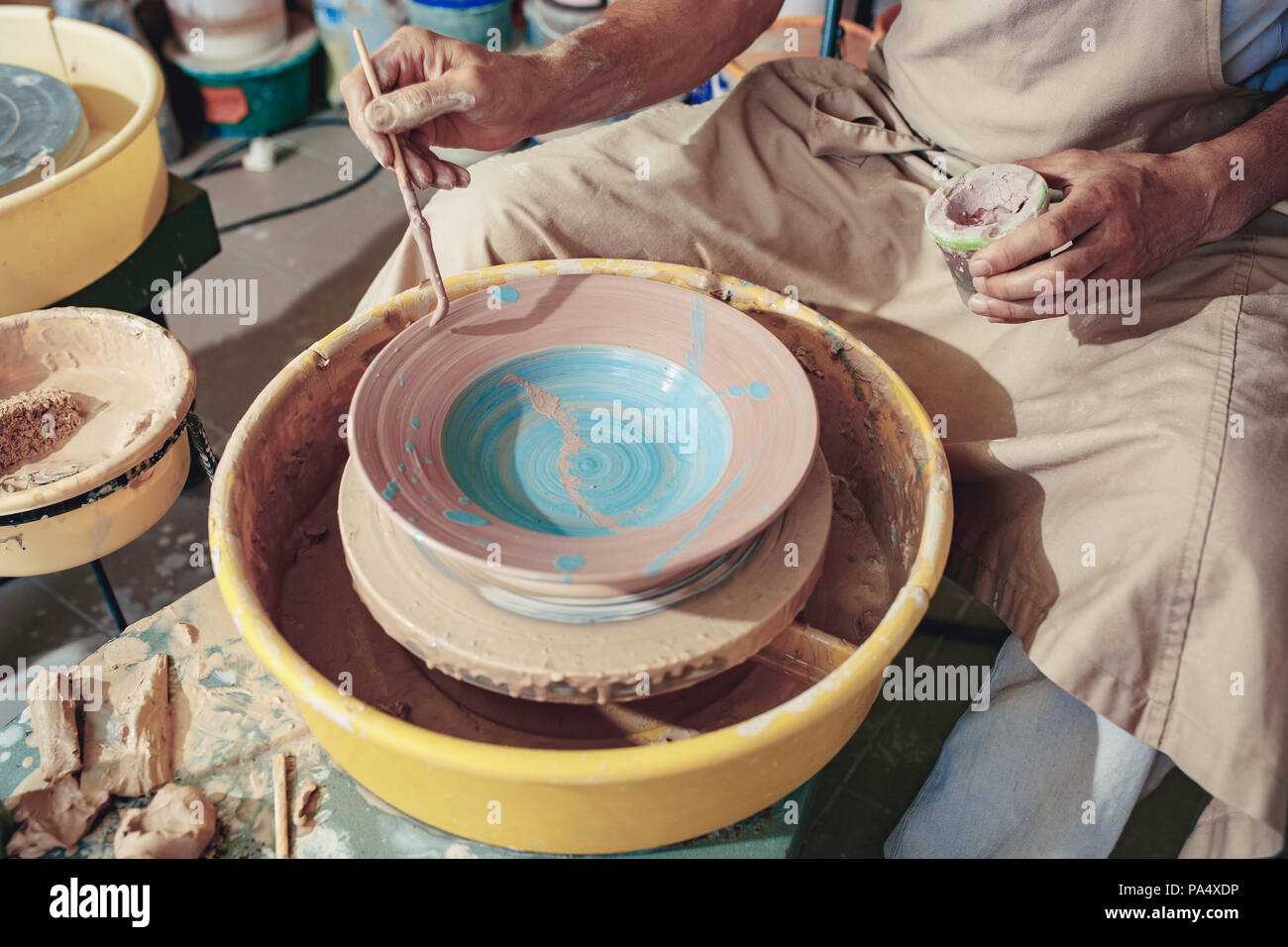 Creating a jar or vase of white clay close-up. Master crock. Man hands ...