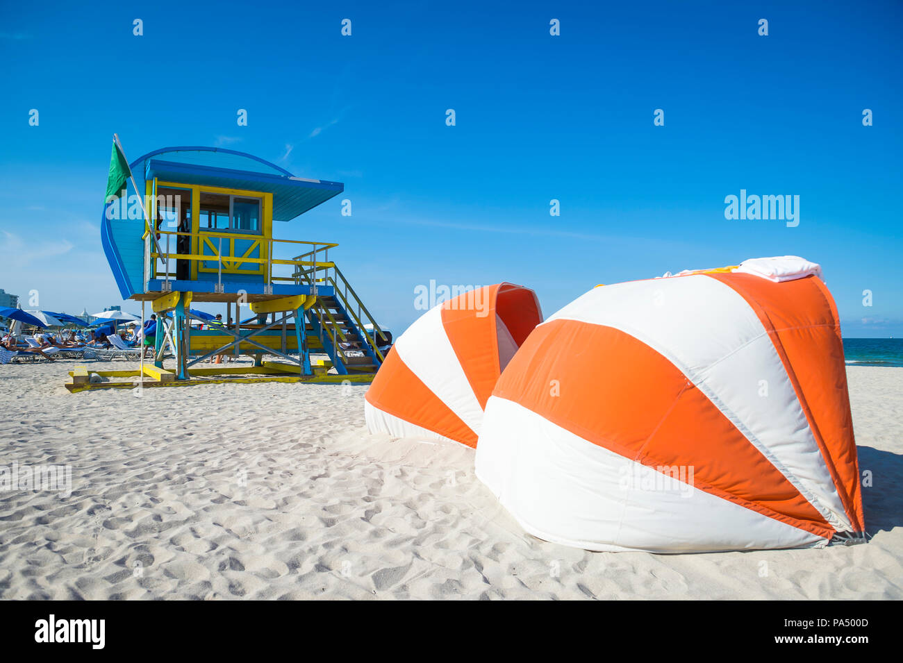 Scenic view of an iconic yellow and blue lifeguard tower and sunshades ...