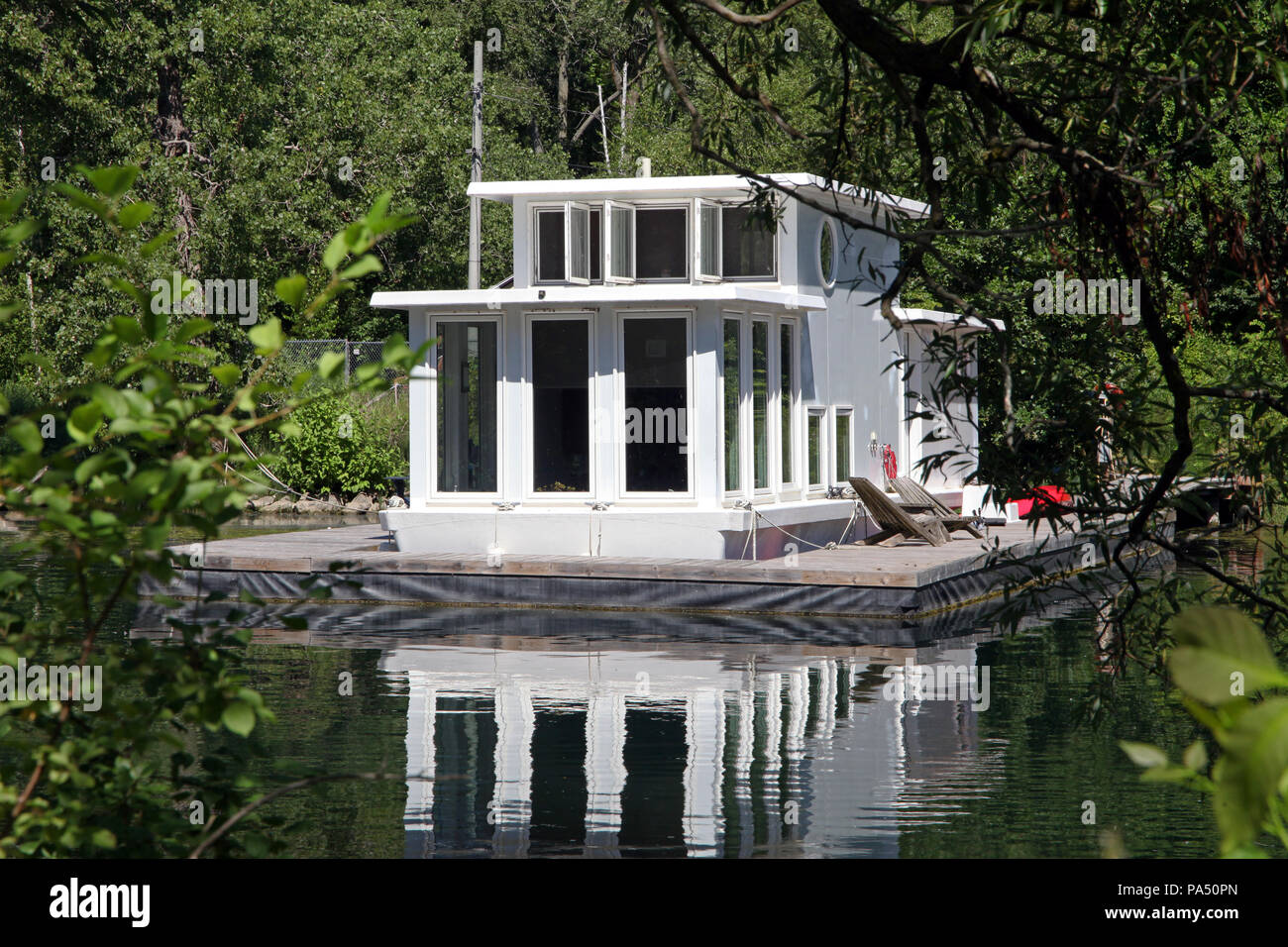 a white houseboat on Lake Ontario on Toronto Islands, Ontario, Canada ...