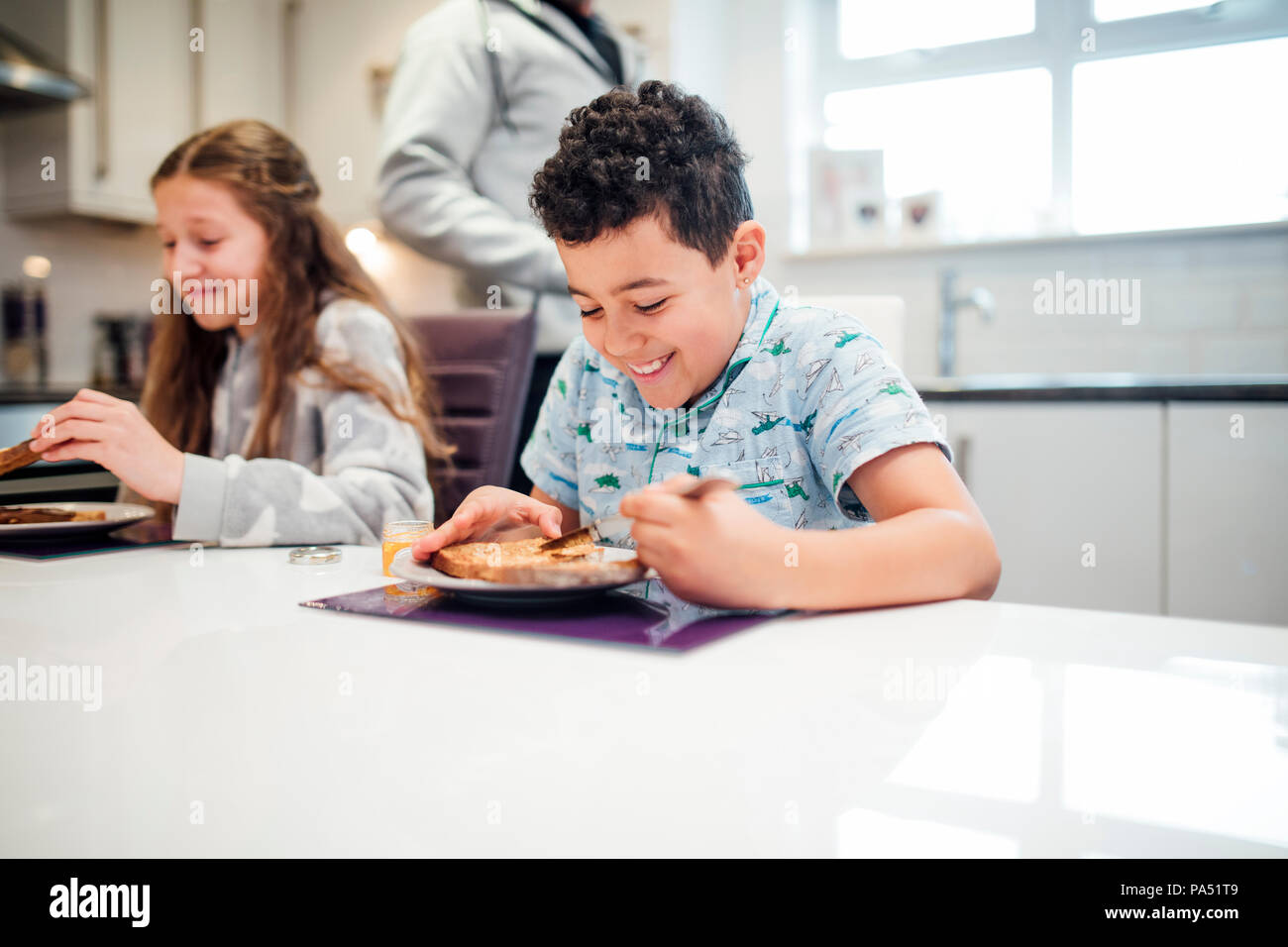 Little boy is enjoying toast with jam for his breakfast at home Stock ...