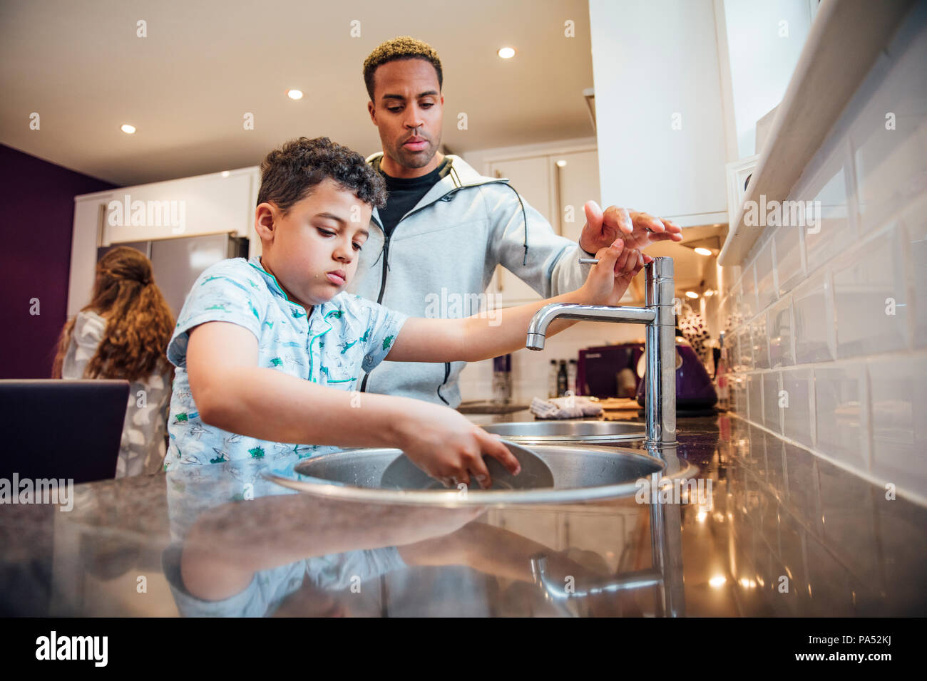Boy washing dishes hi-res stock photography and images - Alamy