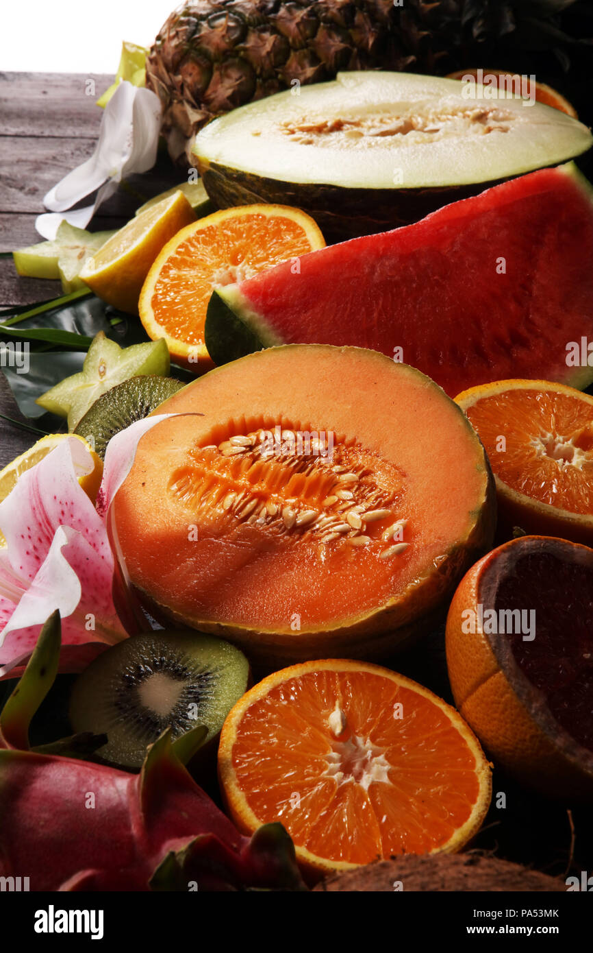Tropical fruit. Assortment of tropical fruits with leaves of palm trees ...