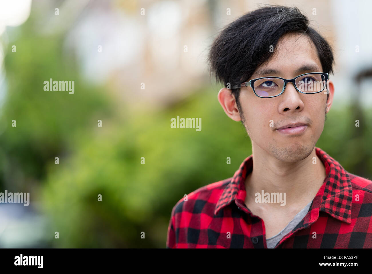Young asian man outdoors hi-res stock photography and images - Alamy
