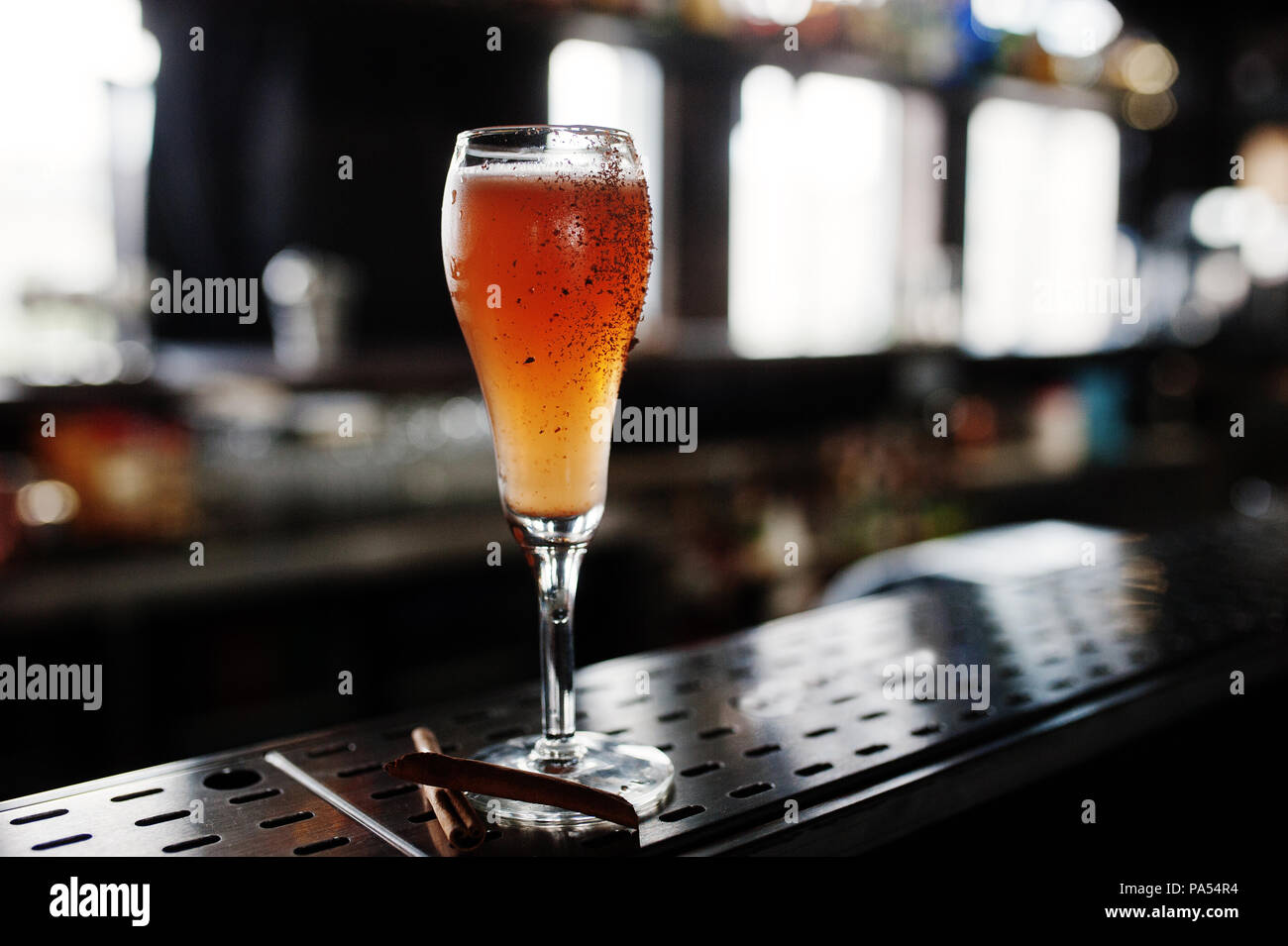 Alcoholic long cocktail with cinnamon at bar table Stock Photo - Alamy