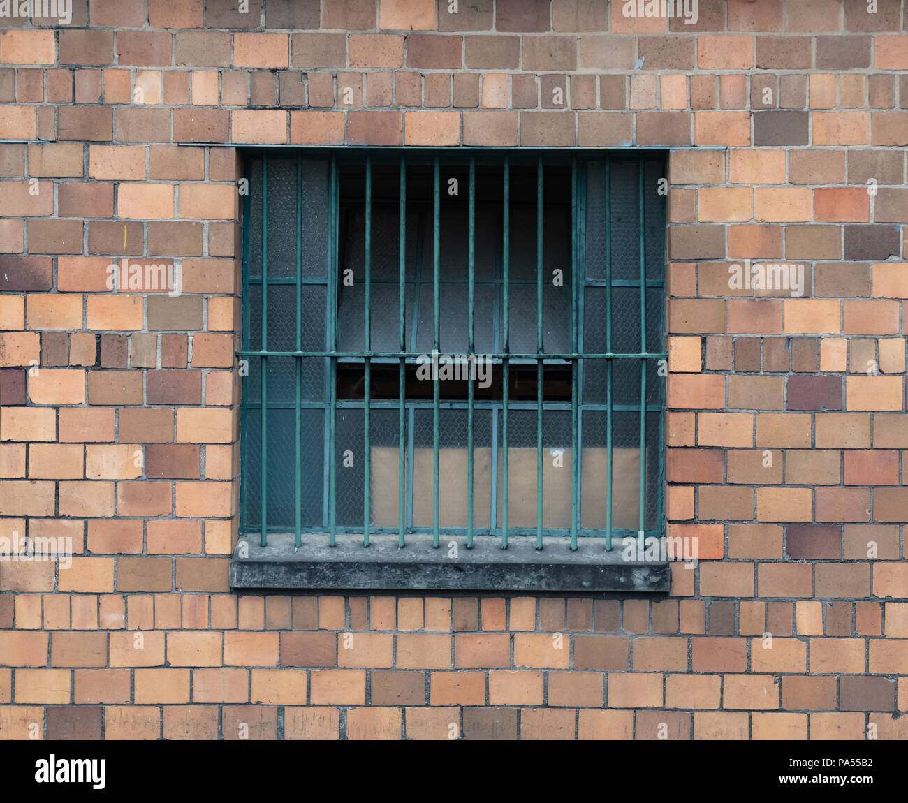 Barred Window In Brick Wall horizontal image Stock Photo - Alamy