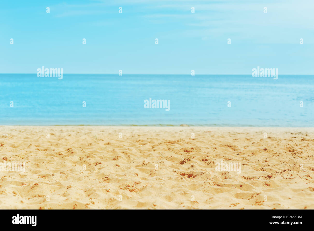 yellow sand beach near blue sea. soft focus on bottom of the picture ...