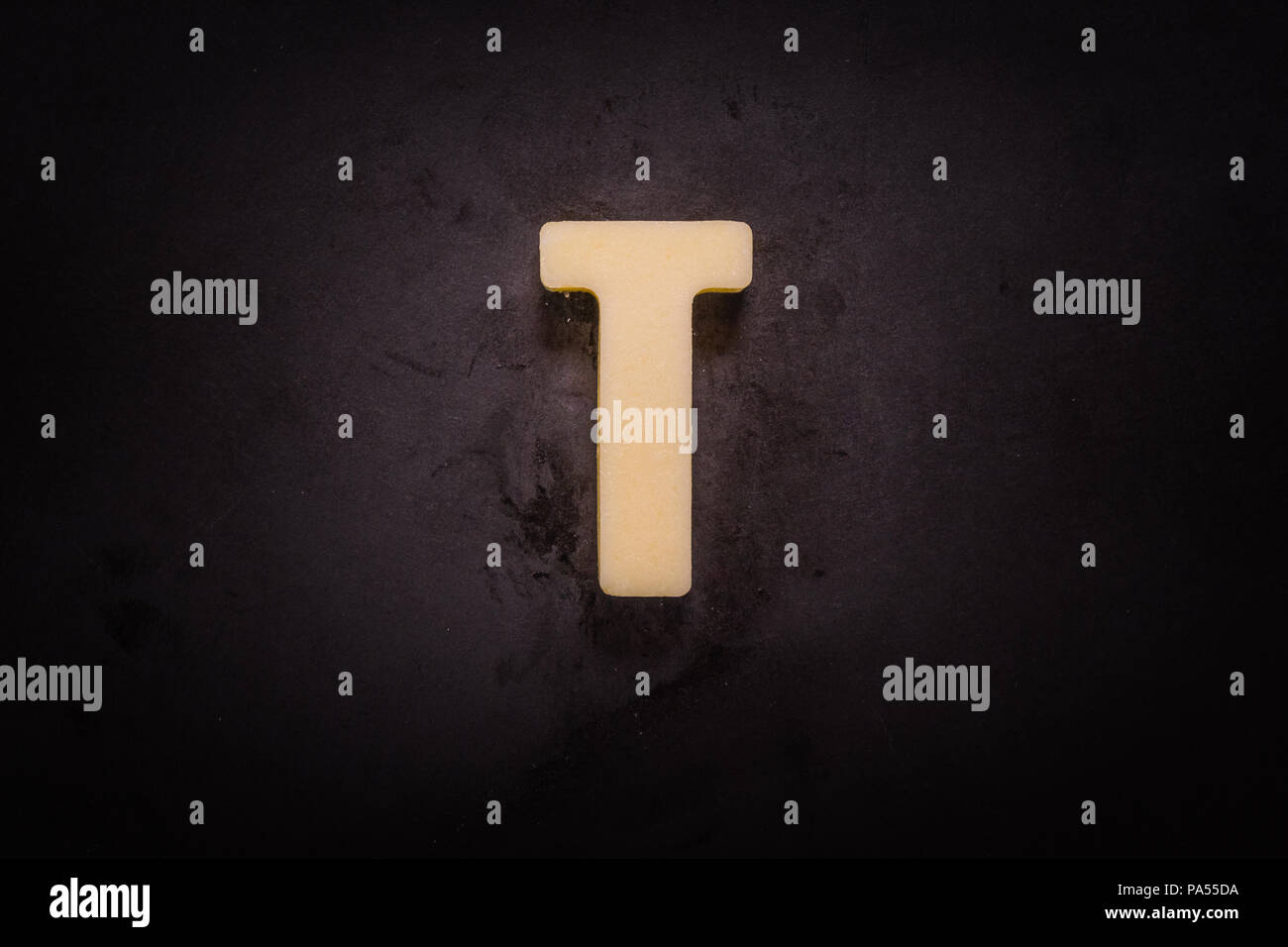 Butter Forms T on cast iron skillet background Stock Photo - Alamy