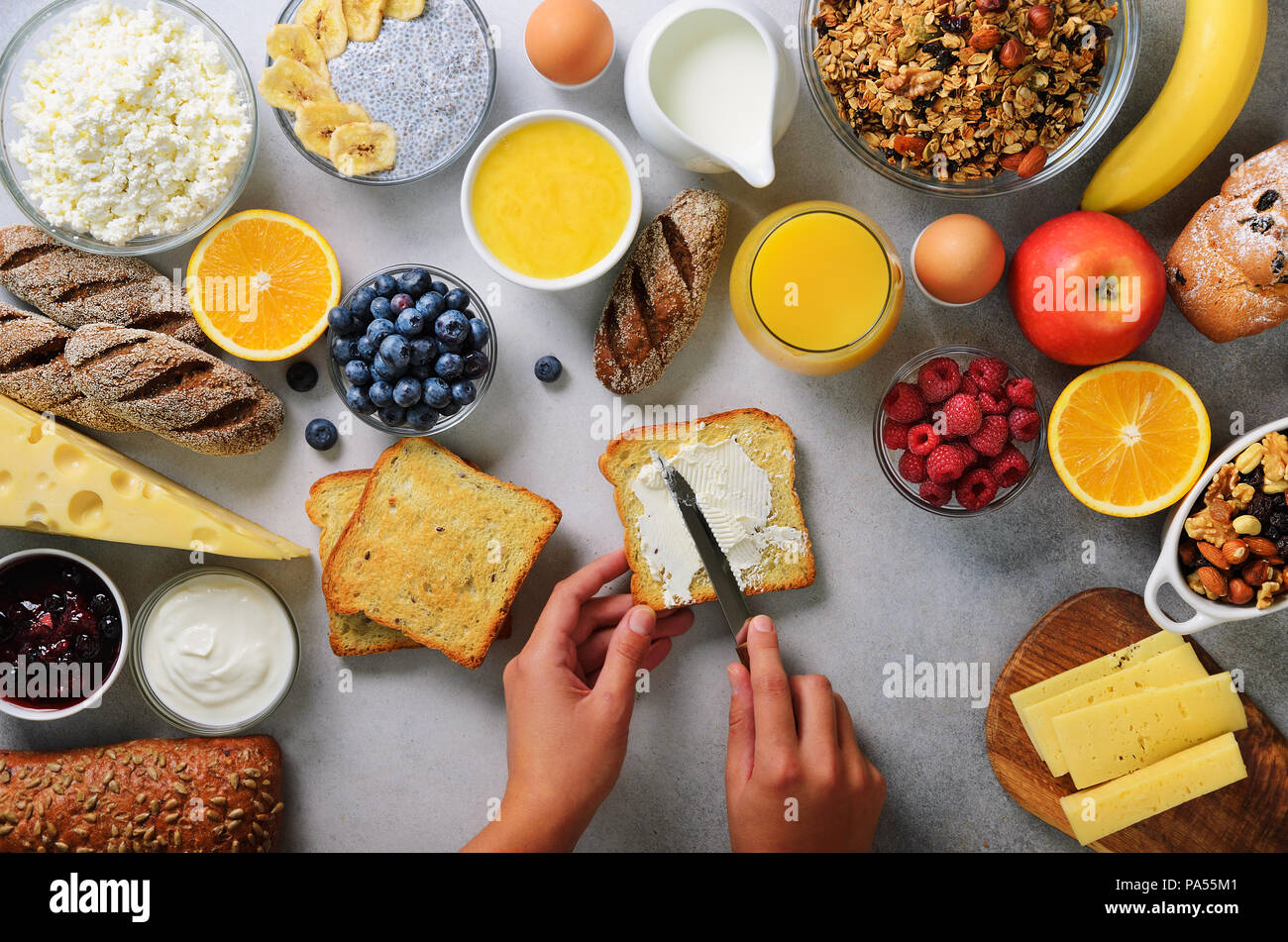 Female hands spreading butter on bread. Woman cooking breakfast ...