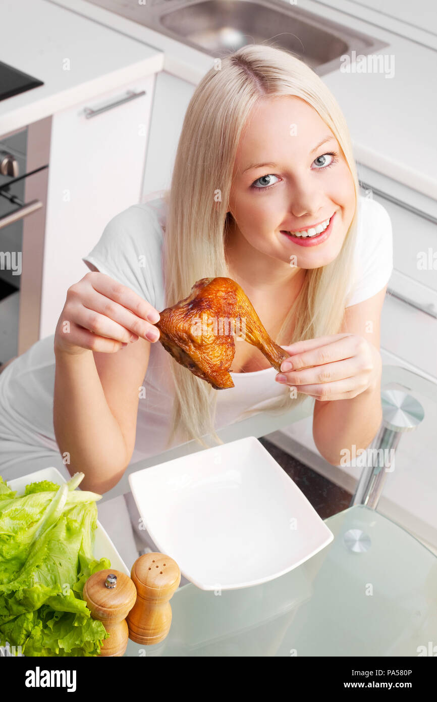 Woman alone eating chicken hi-res stock photography and images - Alamy