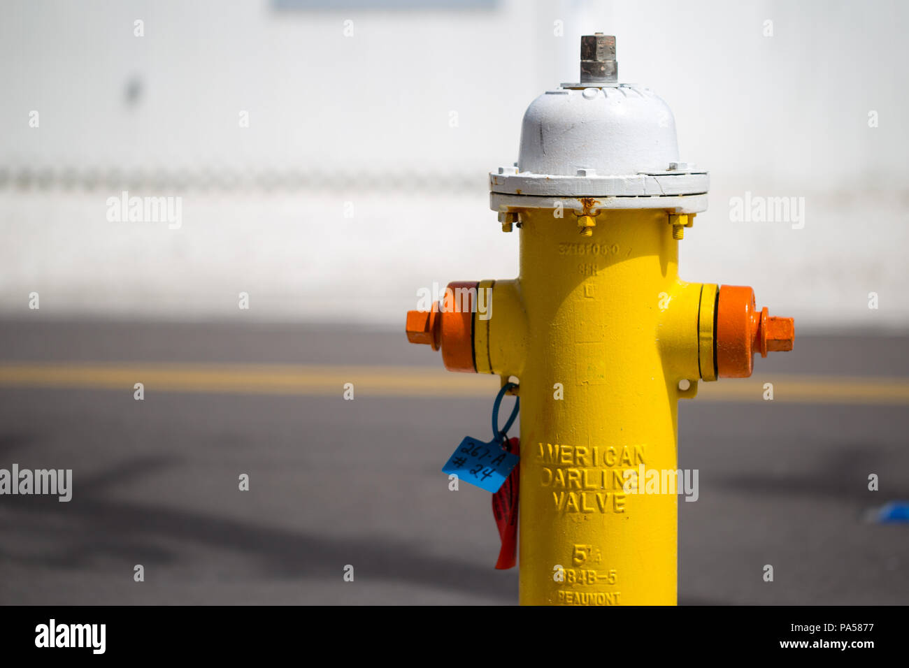 American yellow, white and orange fire hydrant Stock Photo - Alamy