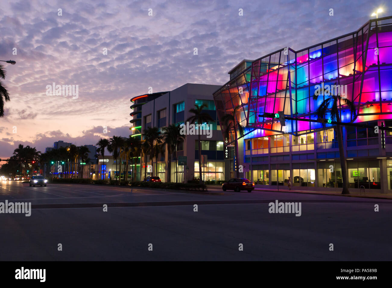 TD Bank, lit up at dawn with multicoloured lights, Collins Avenue ...