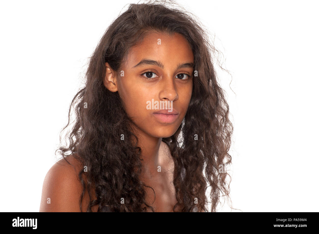 portrait of serious beautiful dark skin girl without makeup on a white ...