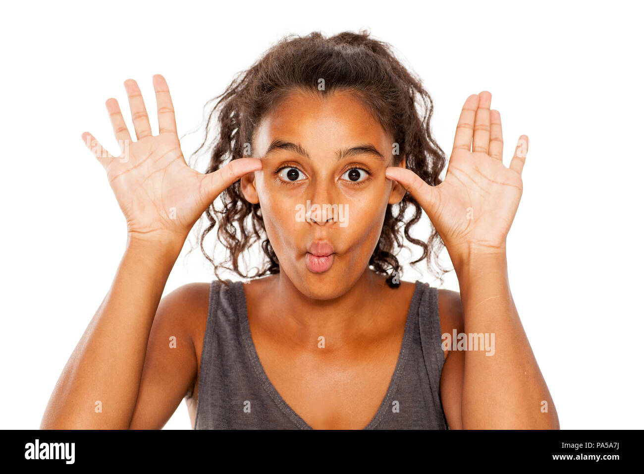 beautiful dark skinned girl making fish faces on white background Stock ...