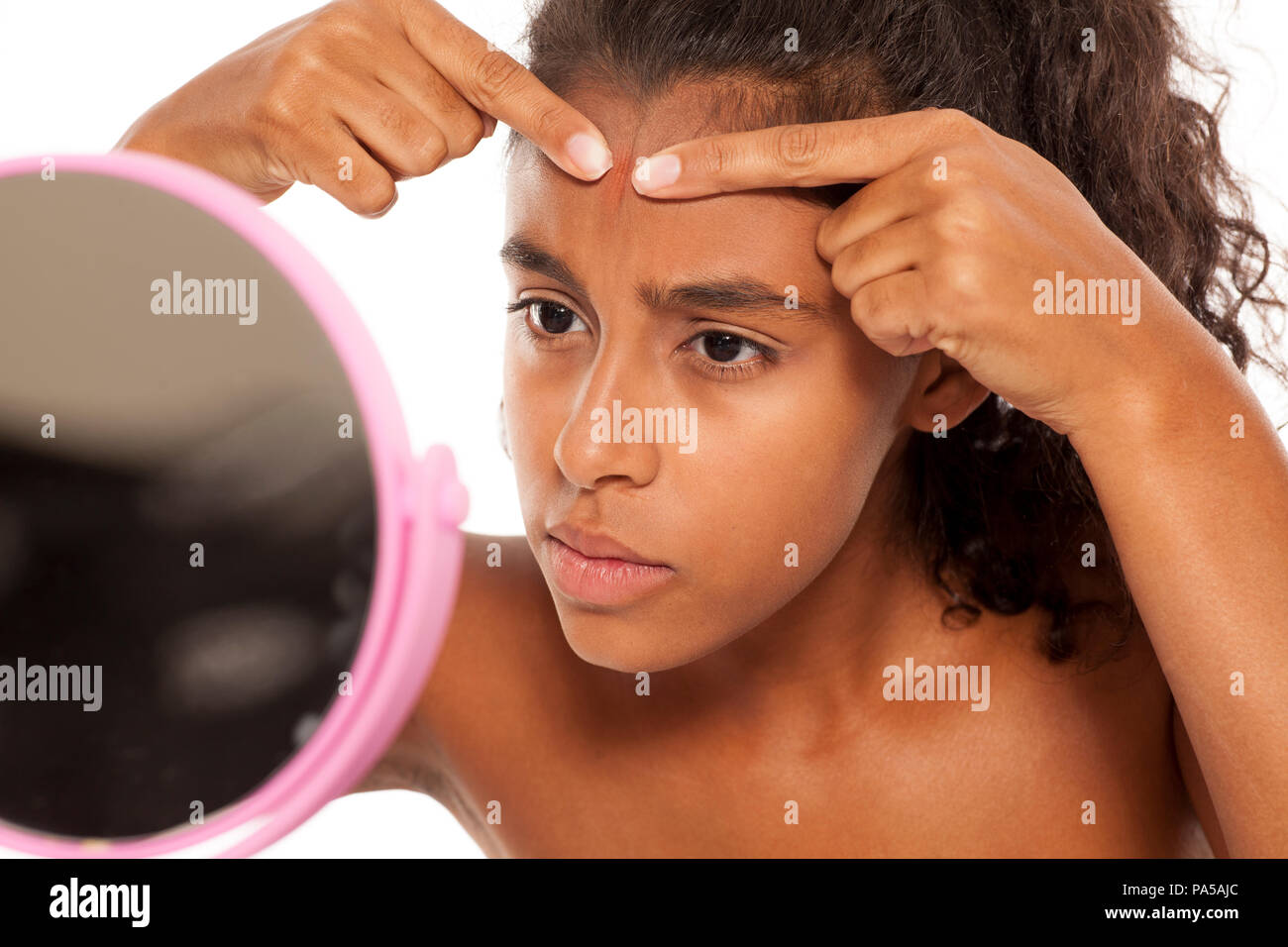 young beautiful black woman squeezing pimples on her face Stock Photo ...