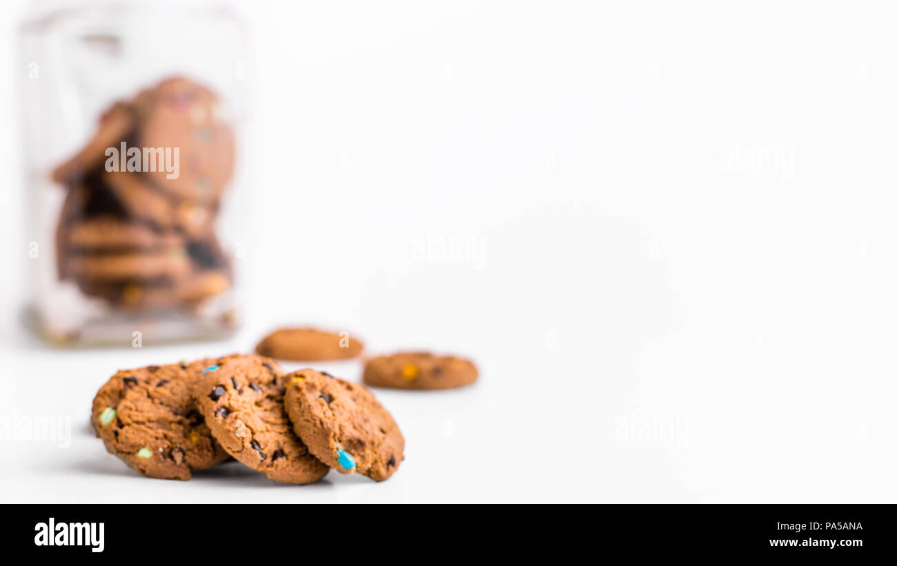 Cookie jar on white background with smartie choc chip biscuits Stock ...