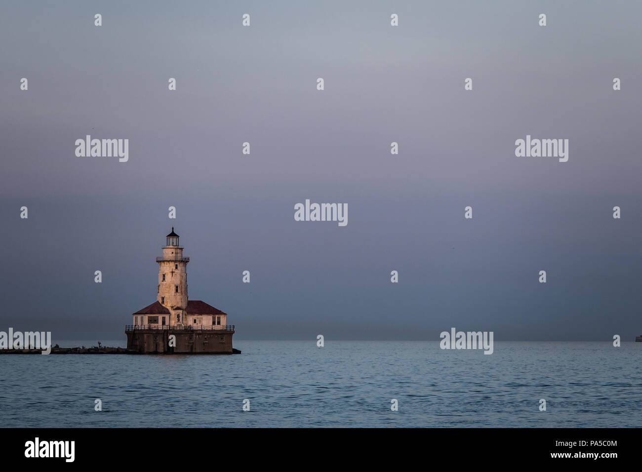 Landscape photo of lighthouse across from Navy Pier at dusk with soft ...