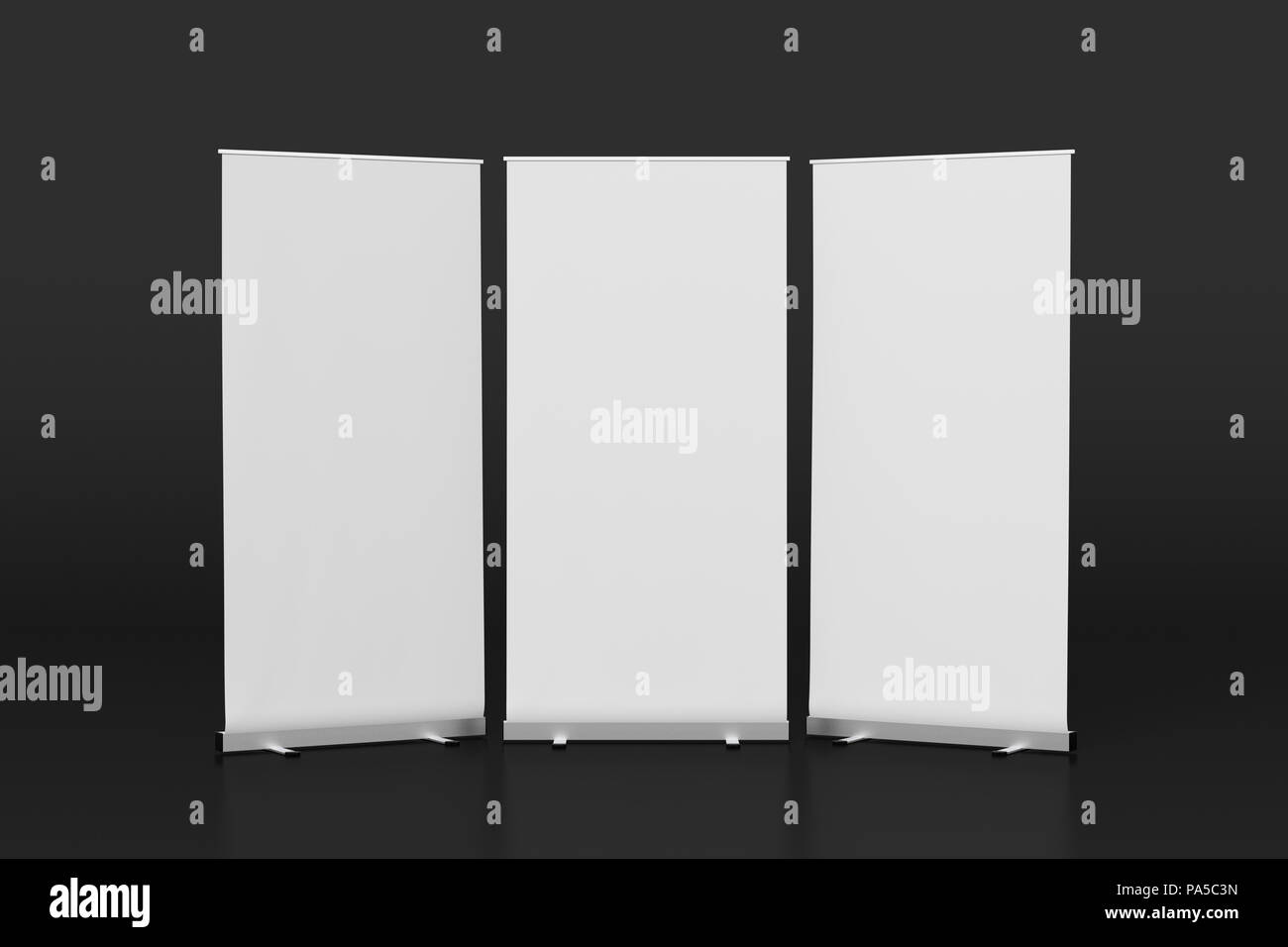 Three blank roll up banner stands isolated on black. Include clipping ...